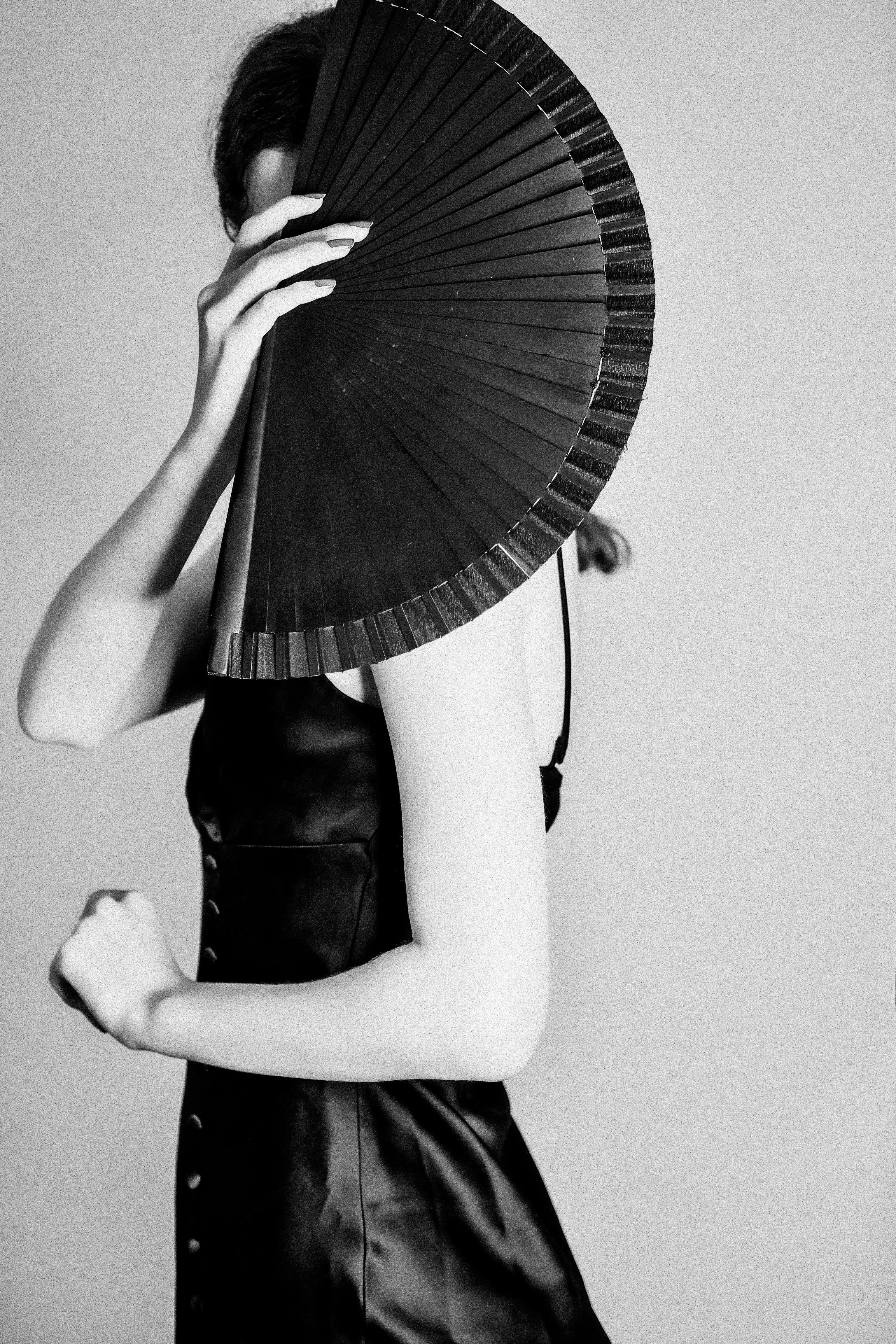 Dancer Hiding Her Face Behind a Hand Fan · Free Stock Photo