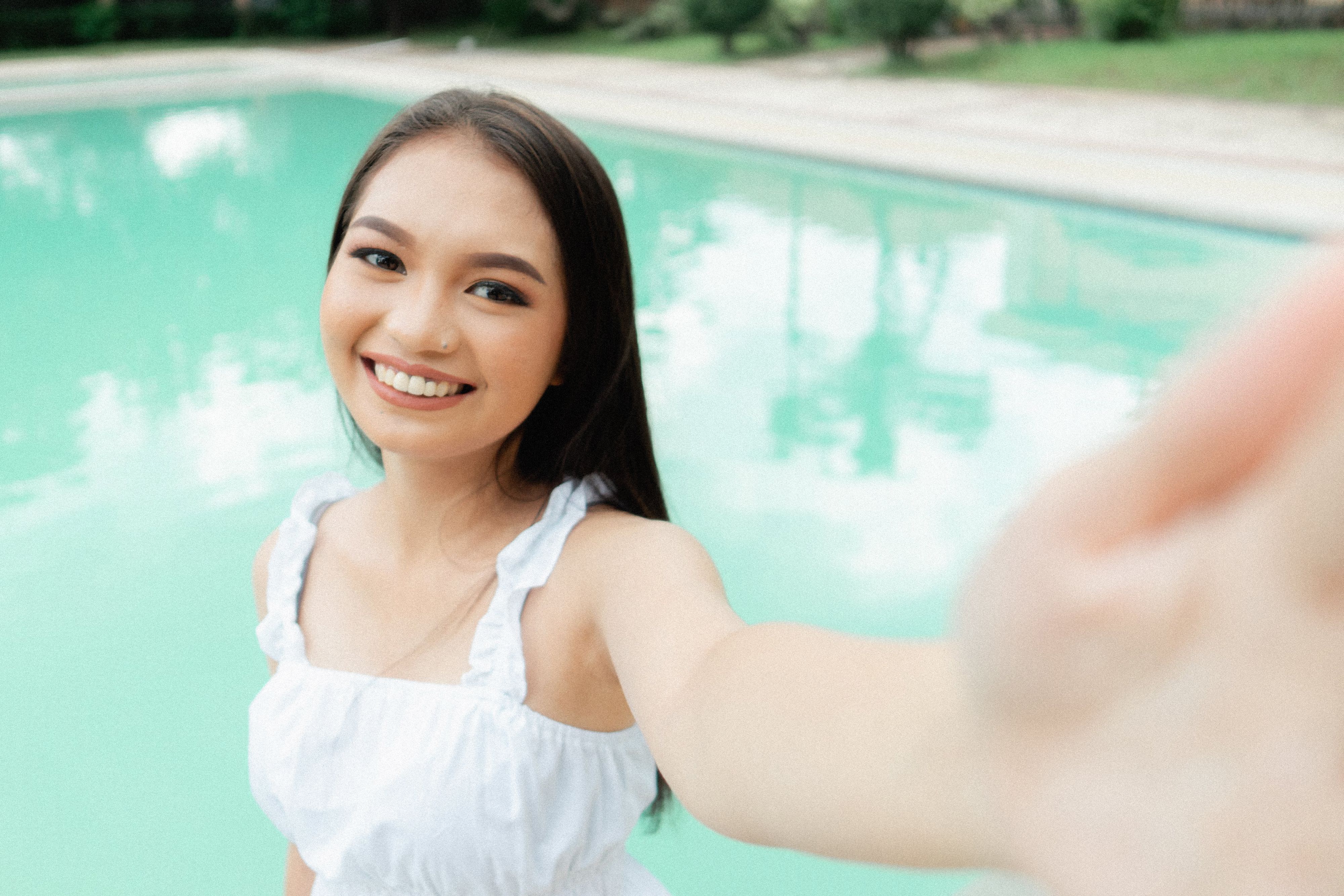 Smiling Woman in Camisole by Swimming Pool · Free Stock Photo