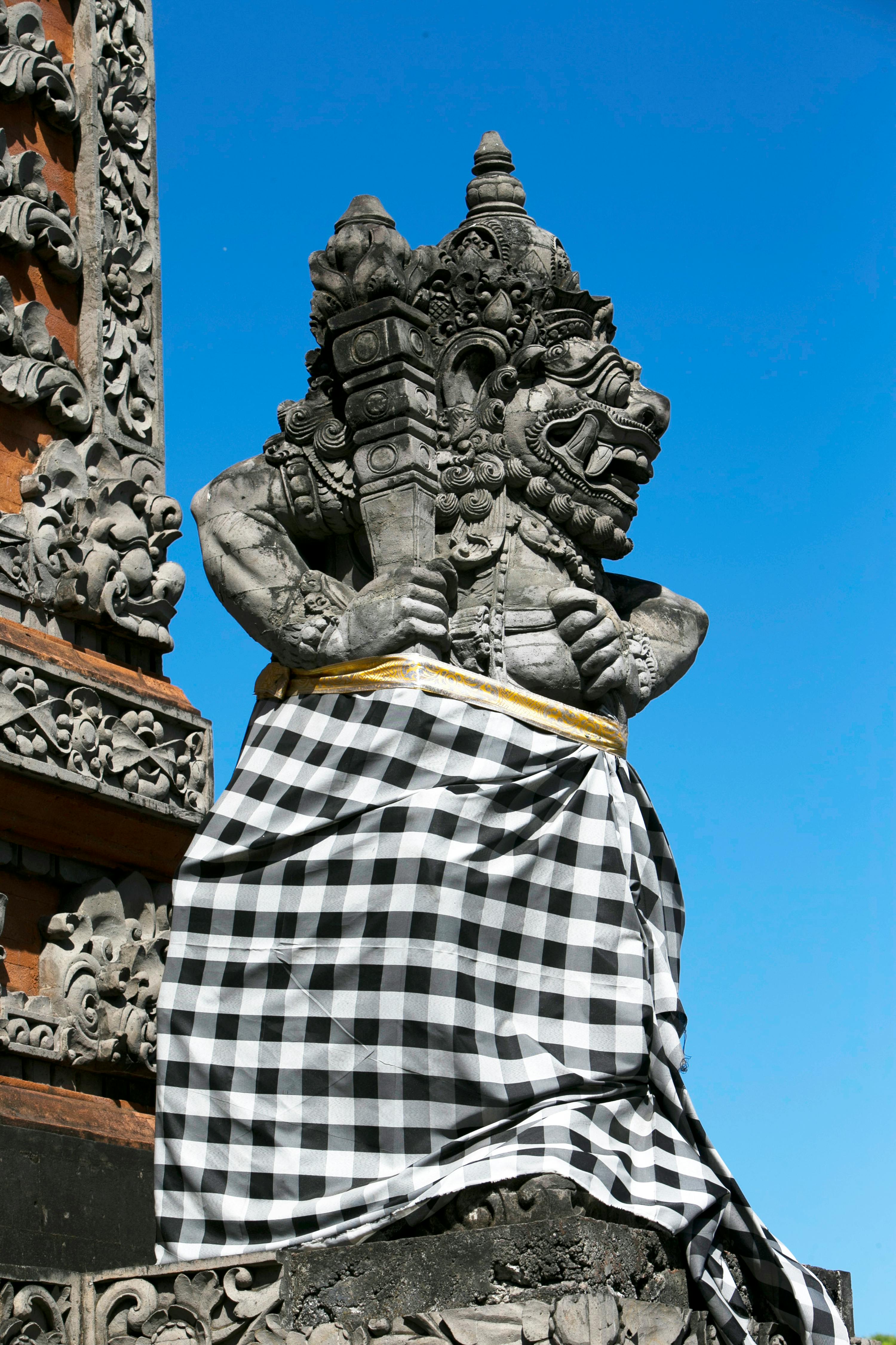 Close-up of a Statue Standing in Front of a Temple · Free Stock Photo