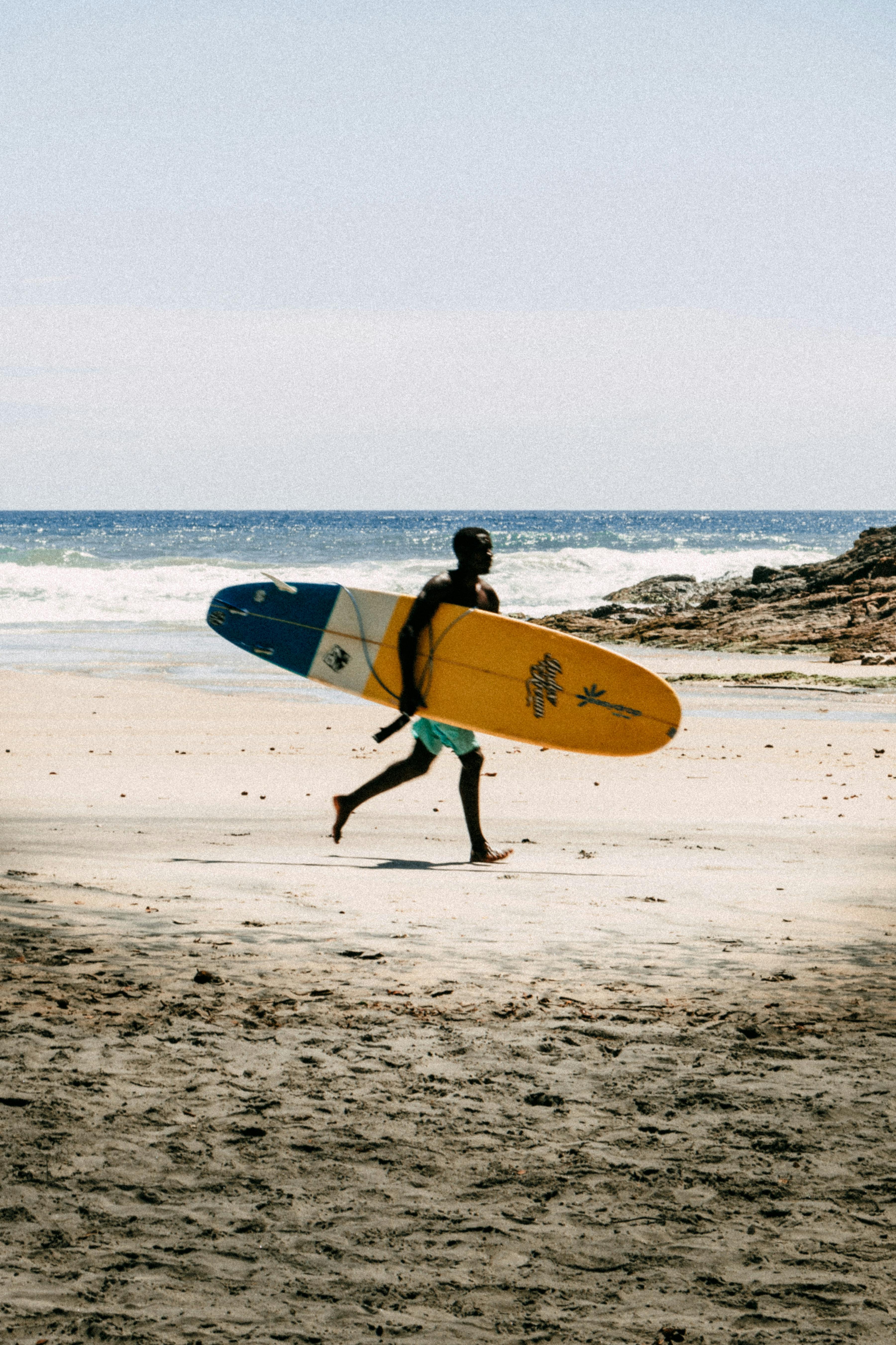 Man Running with Surfboard on Beach · Free Stock Photo
