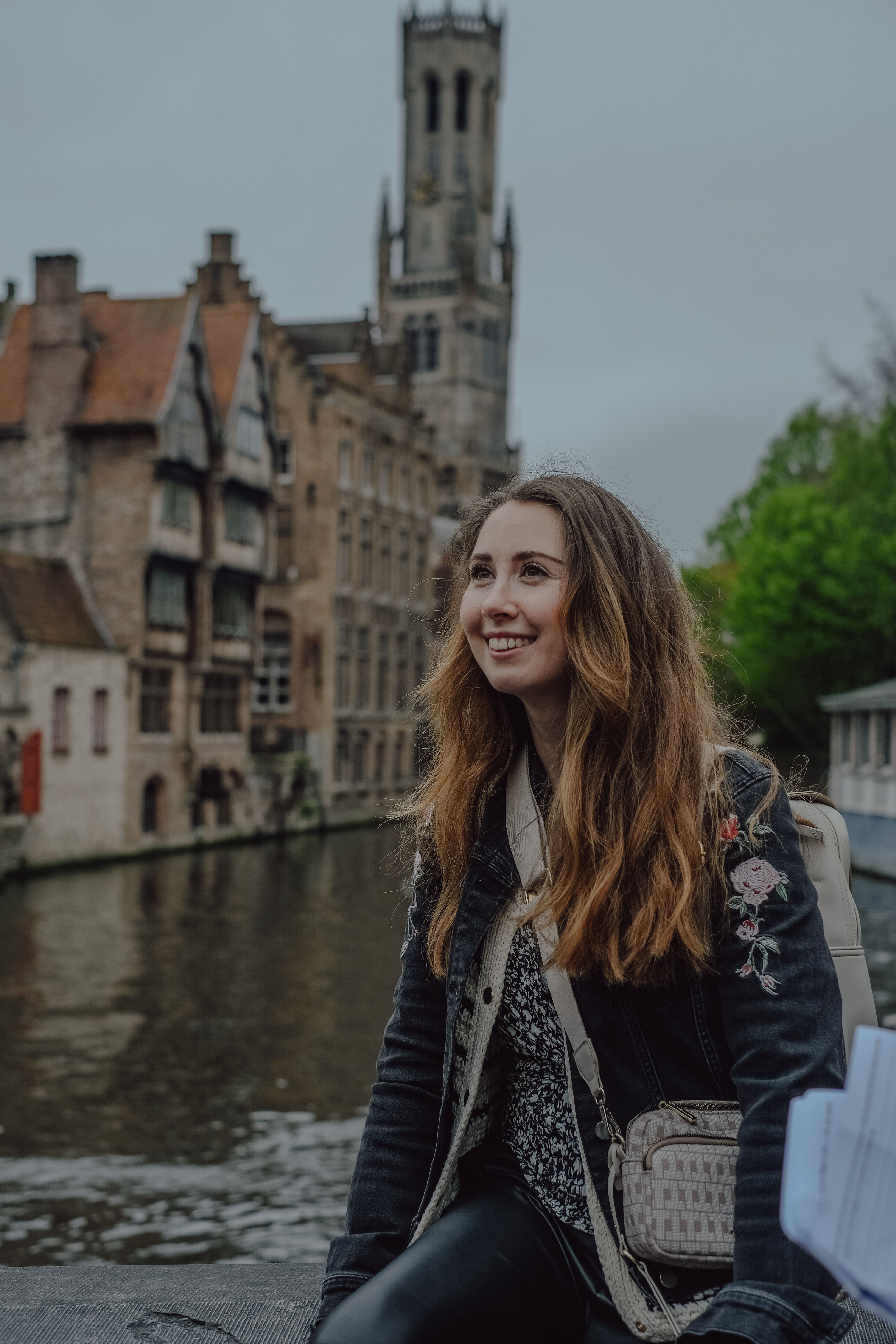 Portrait of Woman Sitting and Smiling in Bruges in Belgium · Free Stock ...