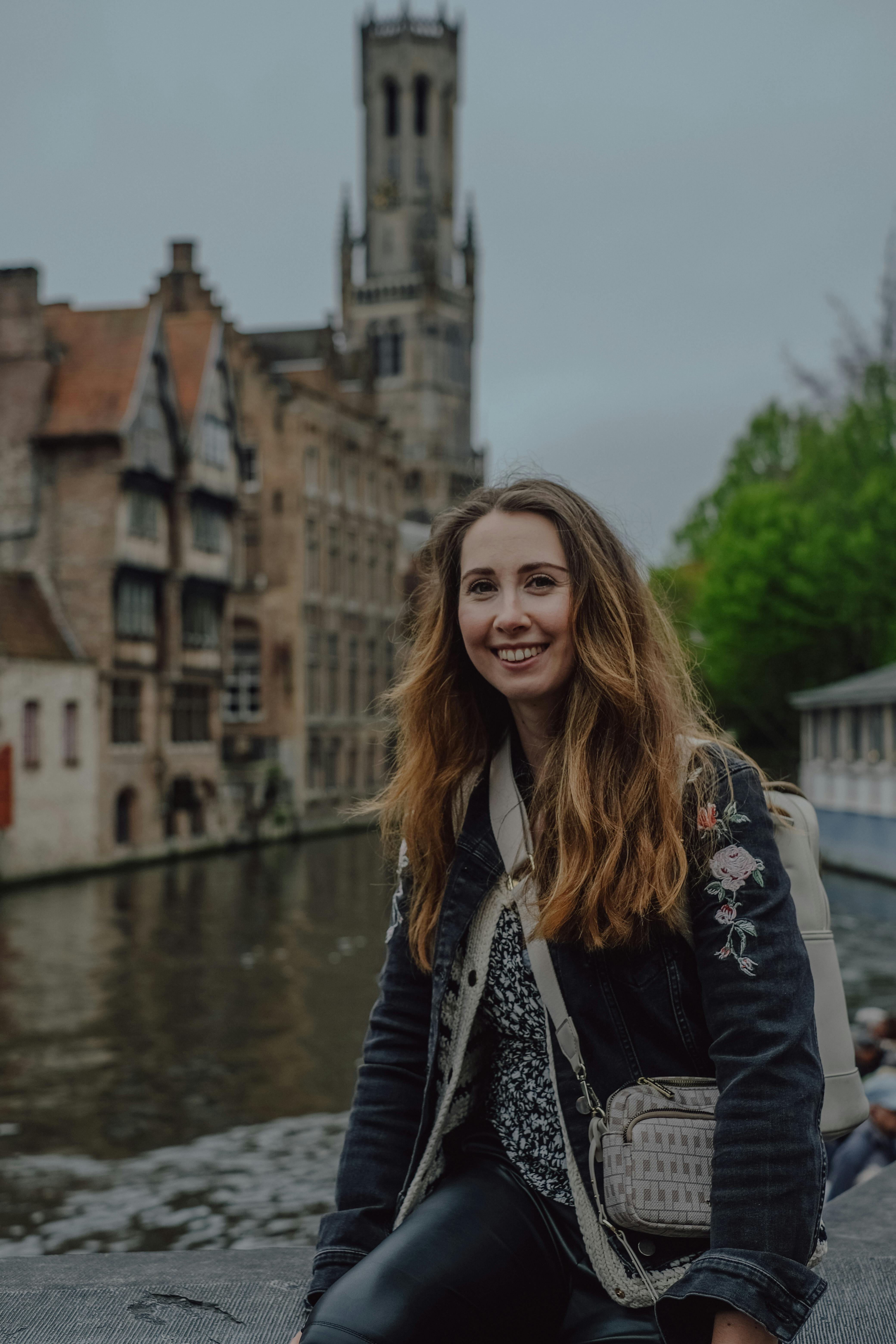 Portrait of Smiling Woman by Canal in Bruges in Belgium · Free Stock Photo