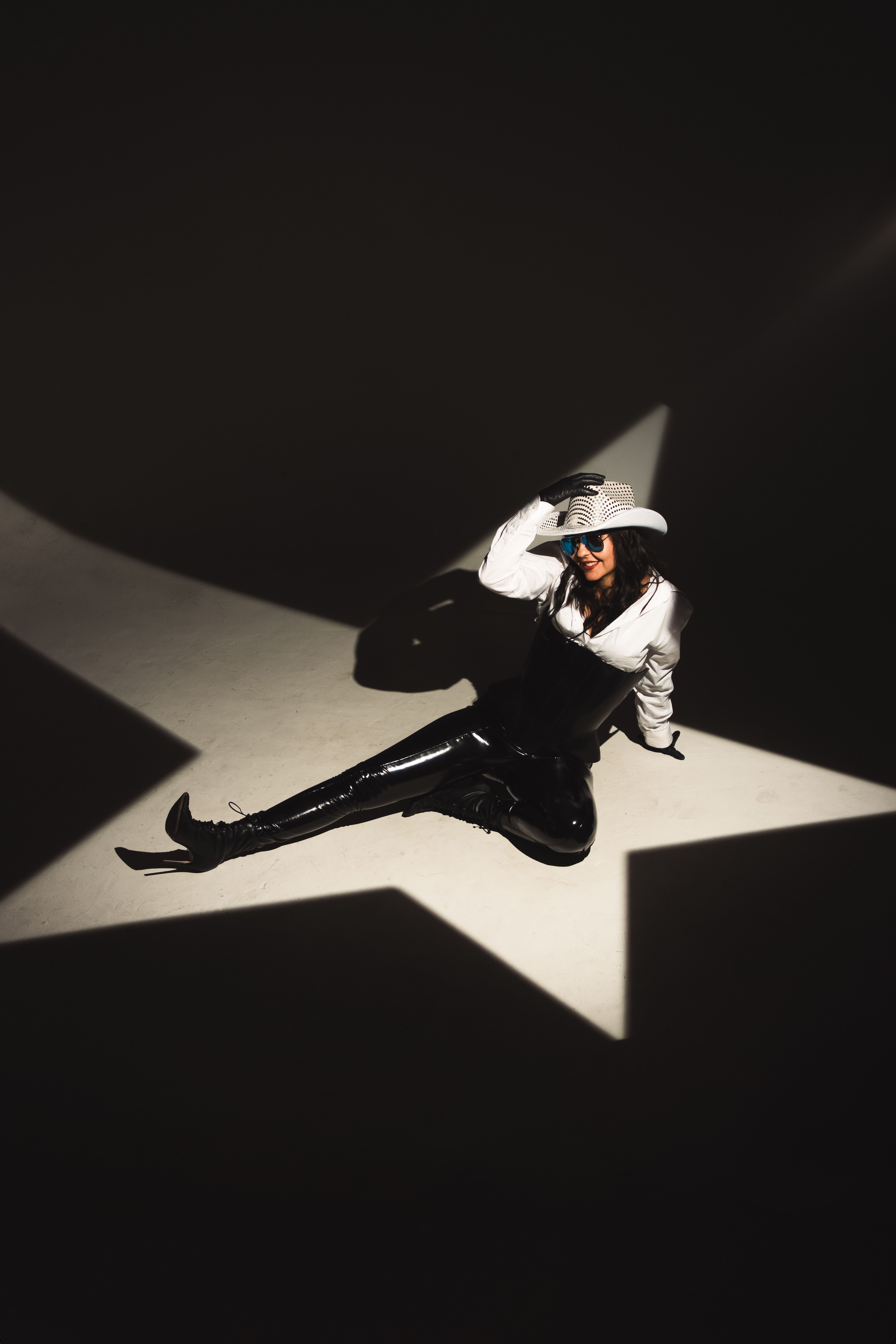 Smiling Woman in Leather and Cowboy Hat Sitting on Star Shape · Free ...