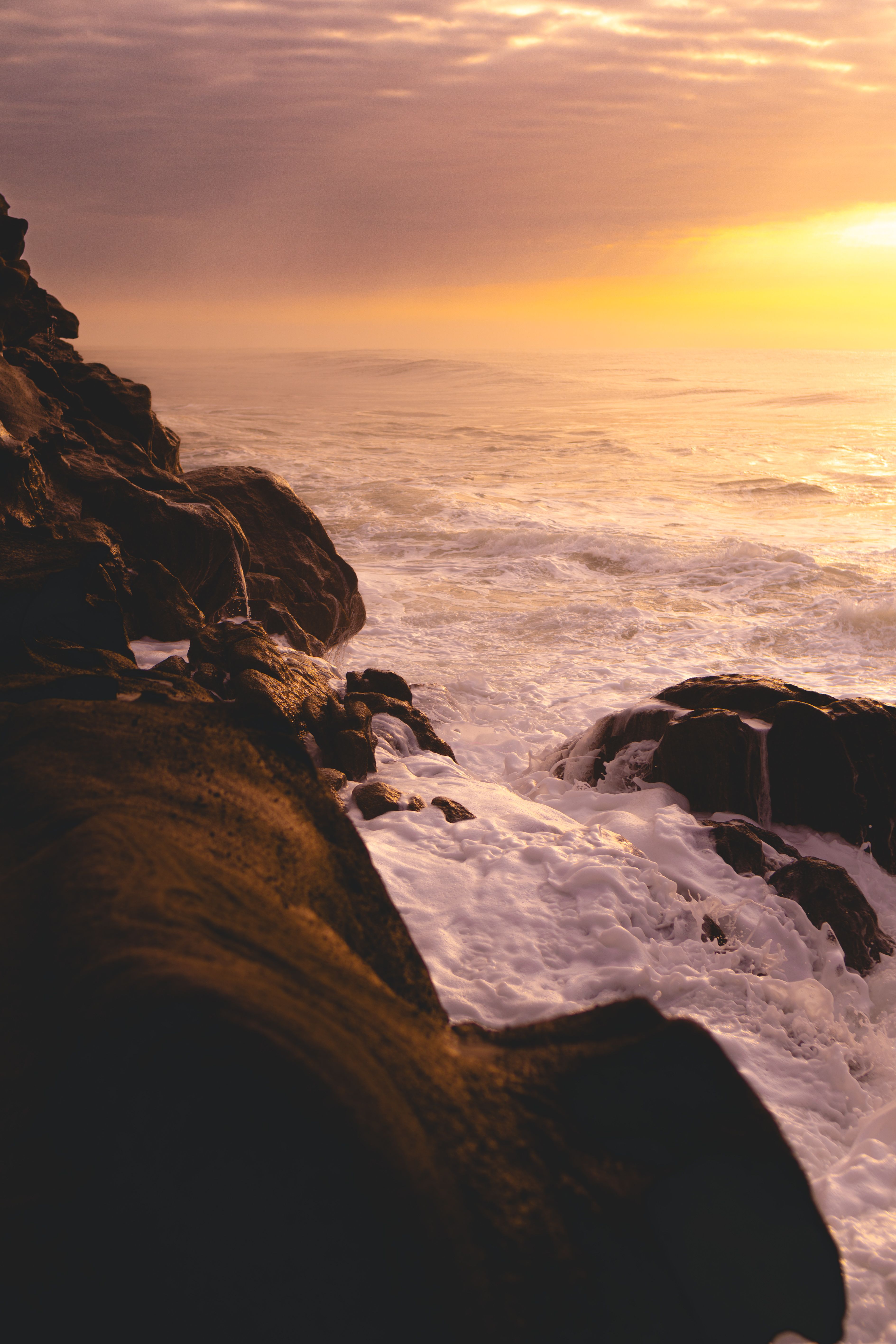 Barren Rocks on Sea Shore at Sunset · Free Stock Photo