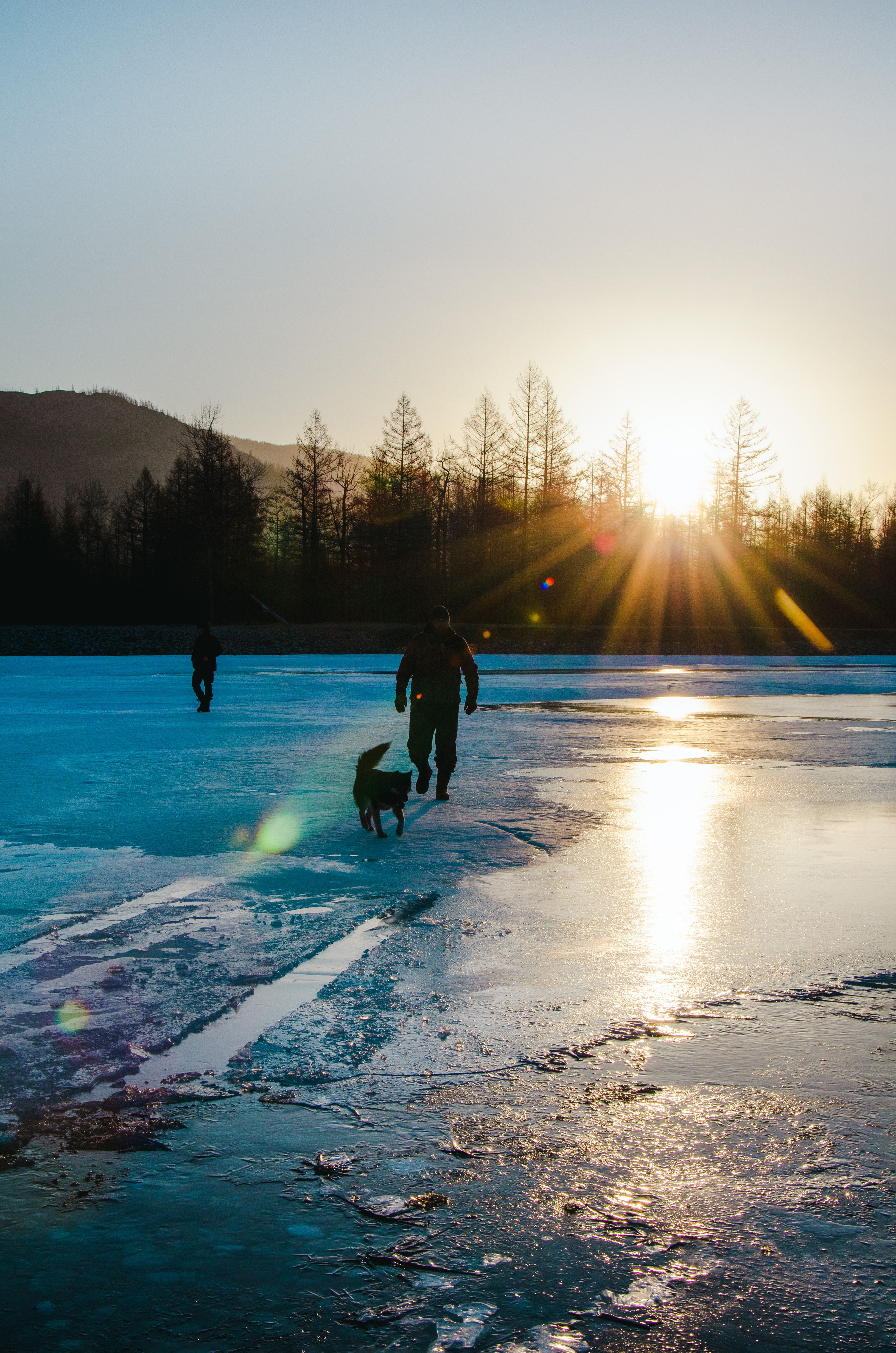 People Walking on a Frozen Body of Water Surface at Sunset · Free Stock ...
