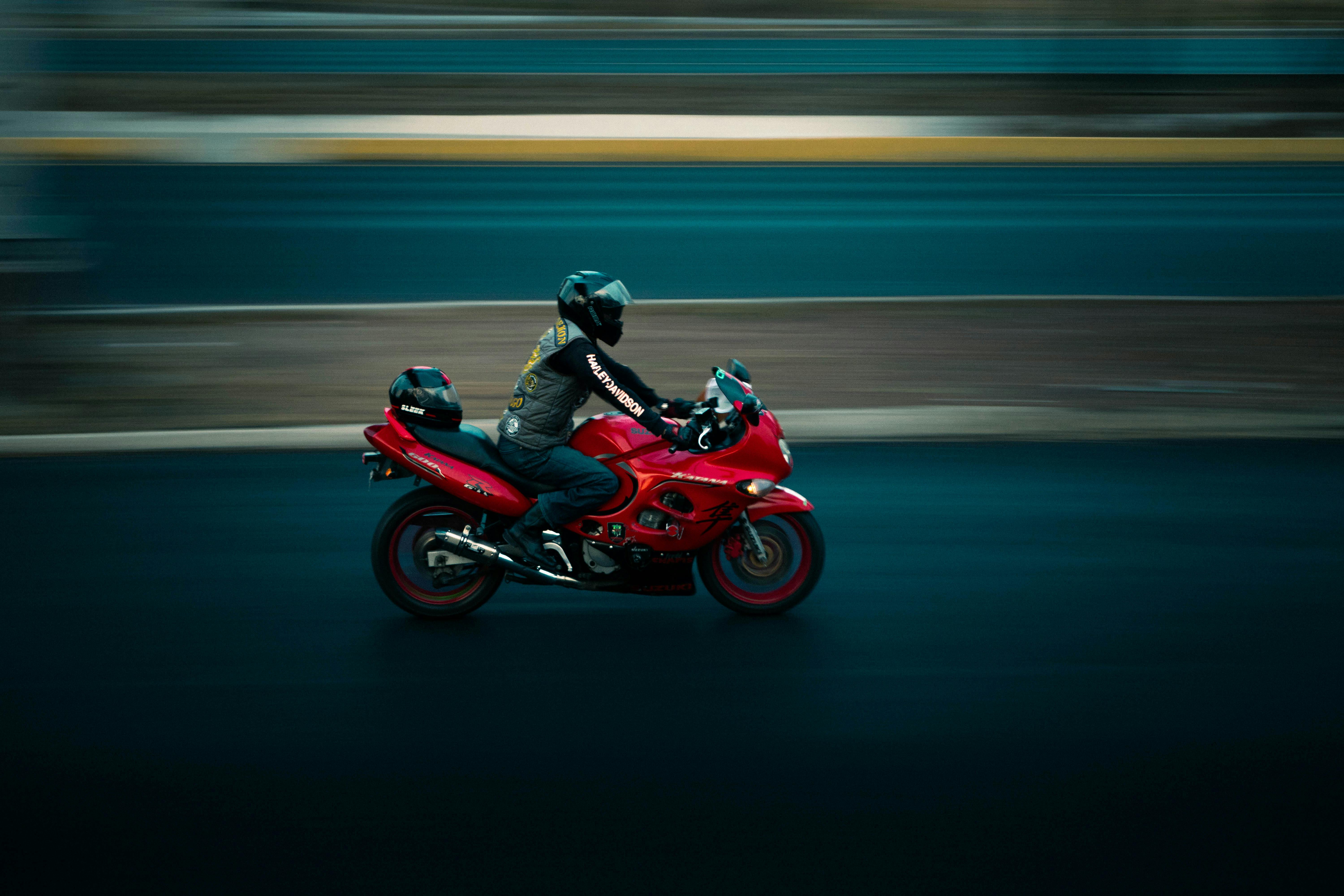 Man Riding Red Suzuki Motorbike · Free Stock Photo