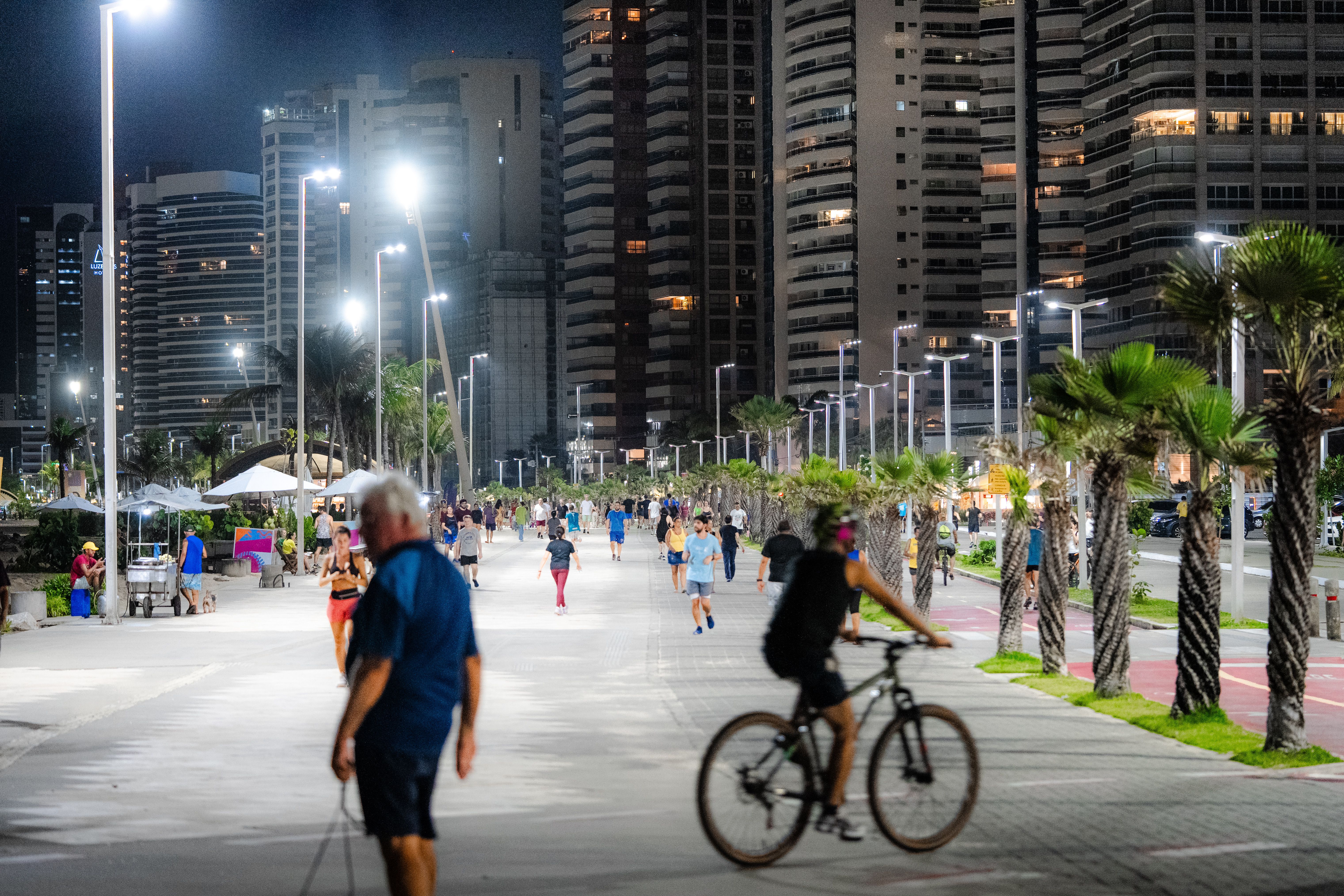 People on Illuminated Promenade at Night · Free Stock Photo