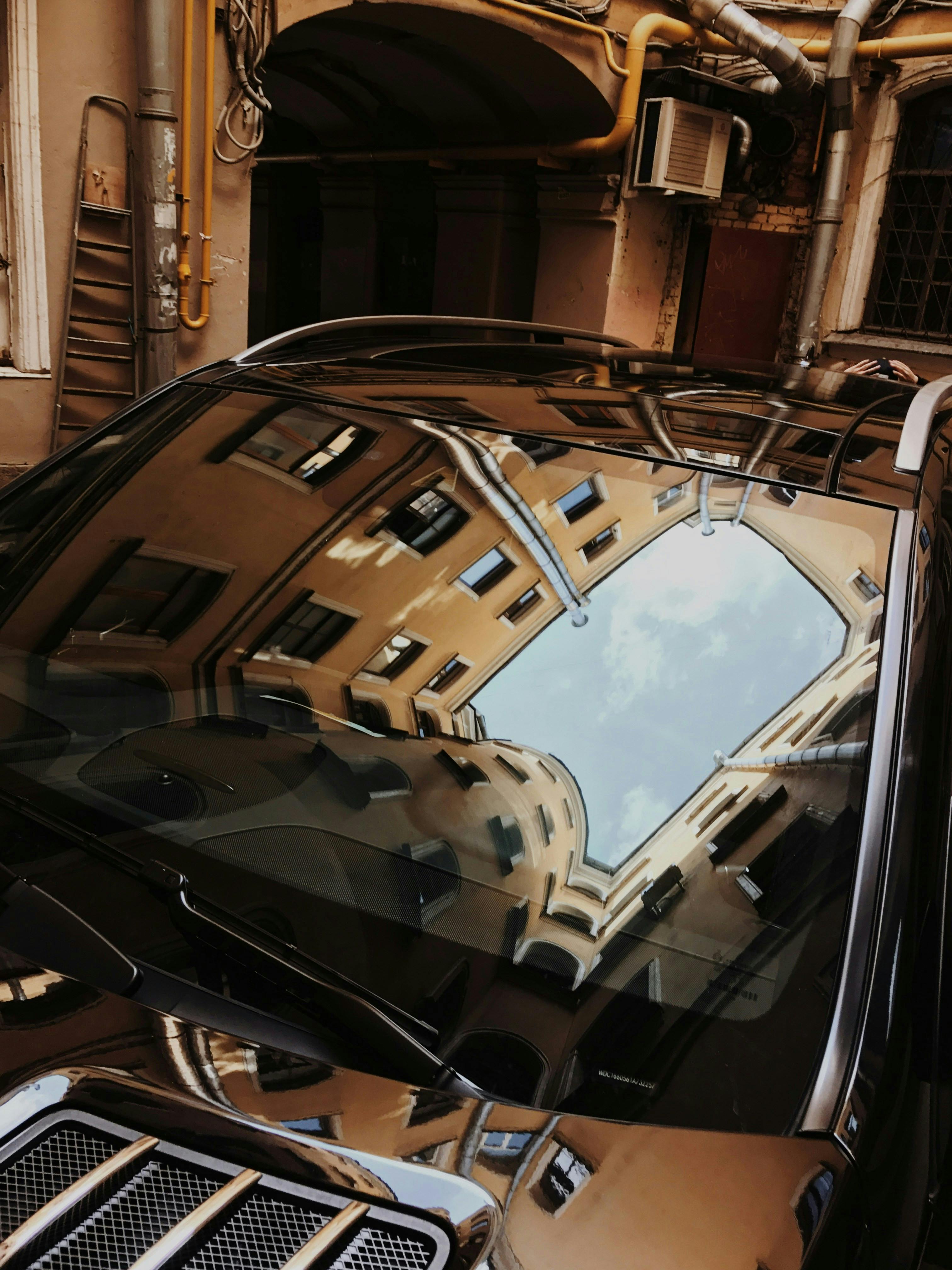 Building Reflection in Car Windshield · Free Stock Photo