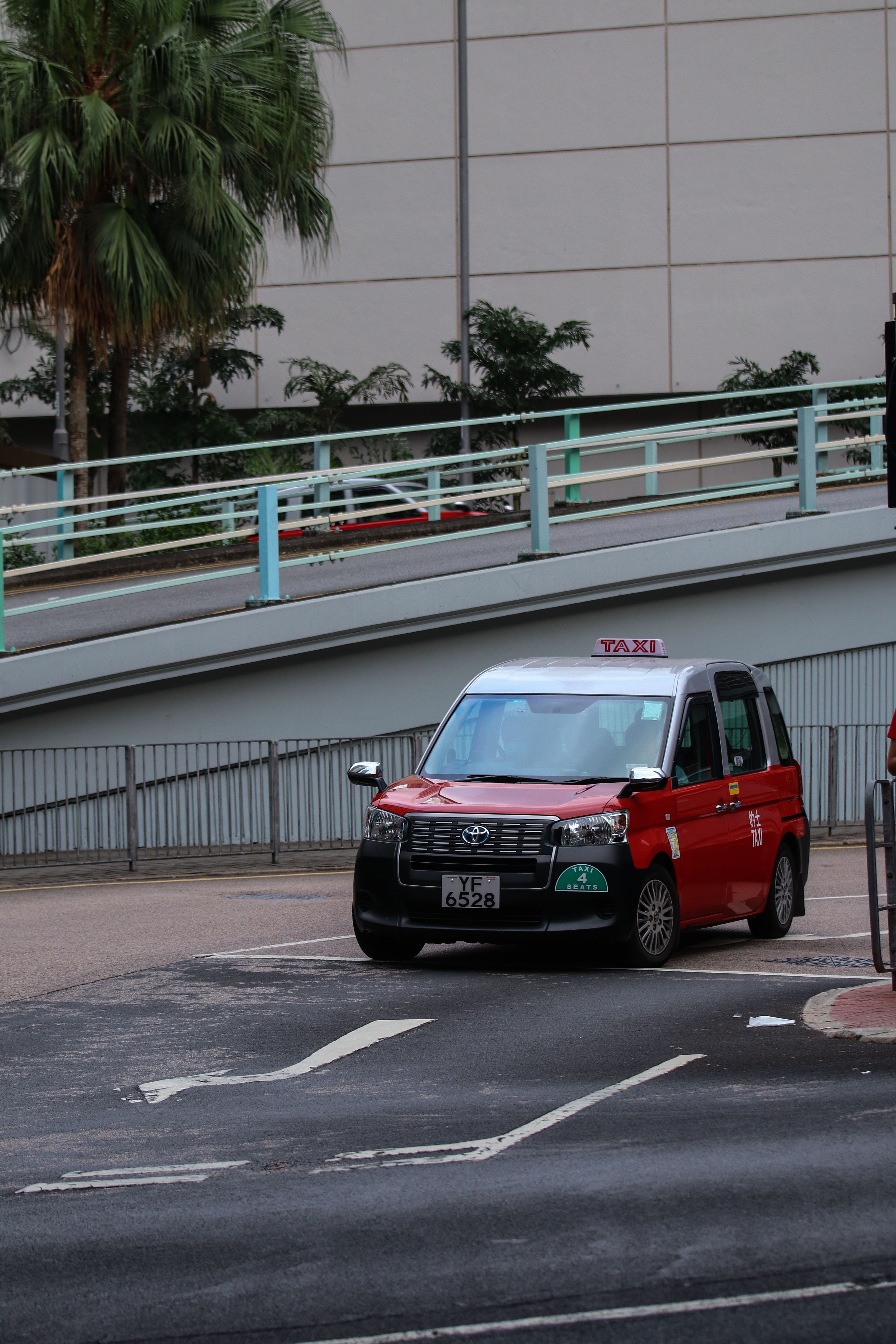 Red Taxi Entering a Street · Free Stock Photo