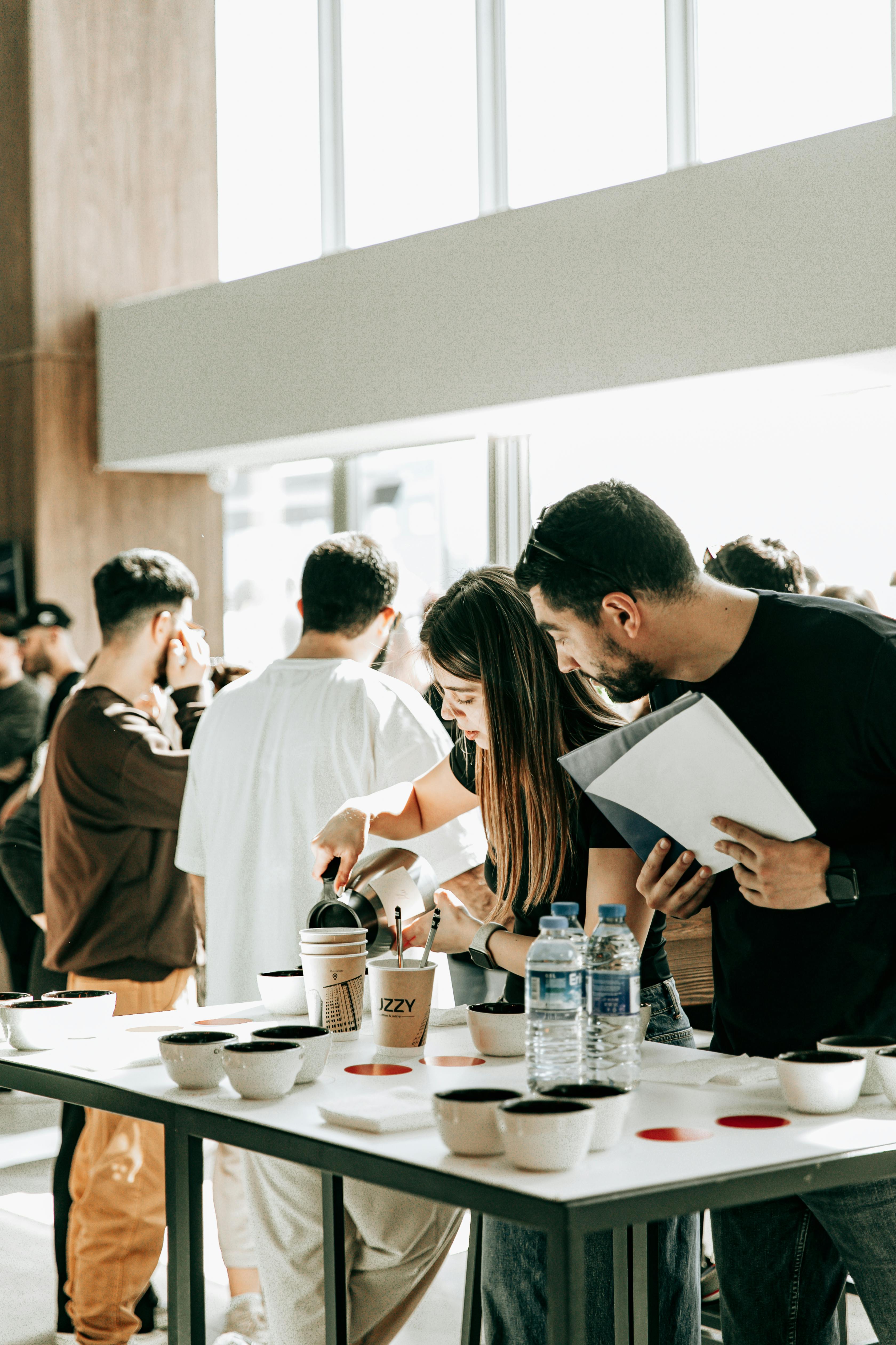 Woman and Man Pouring Coffee in Cup at Business Conference · Free Stock ...
