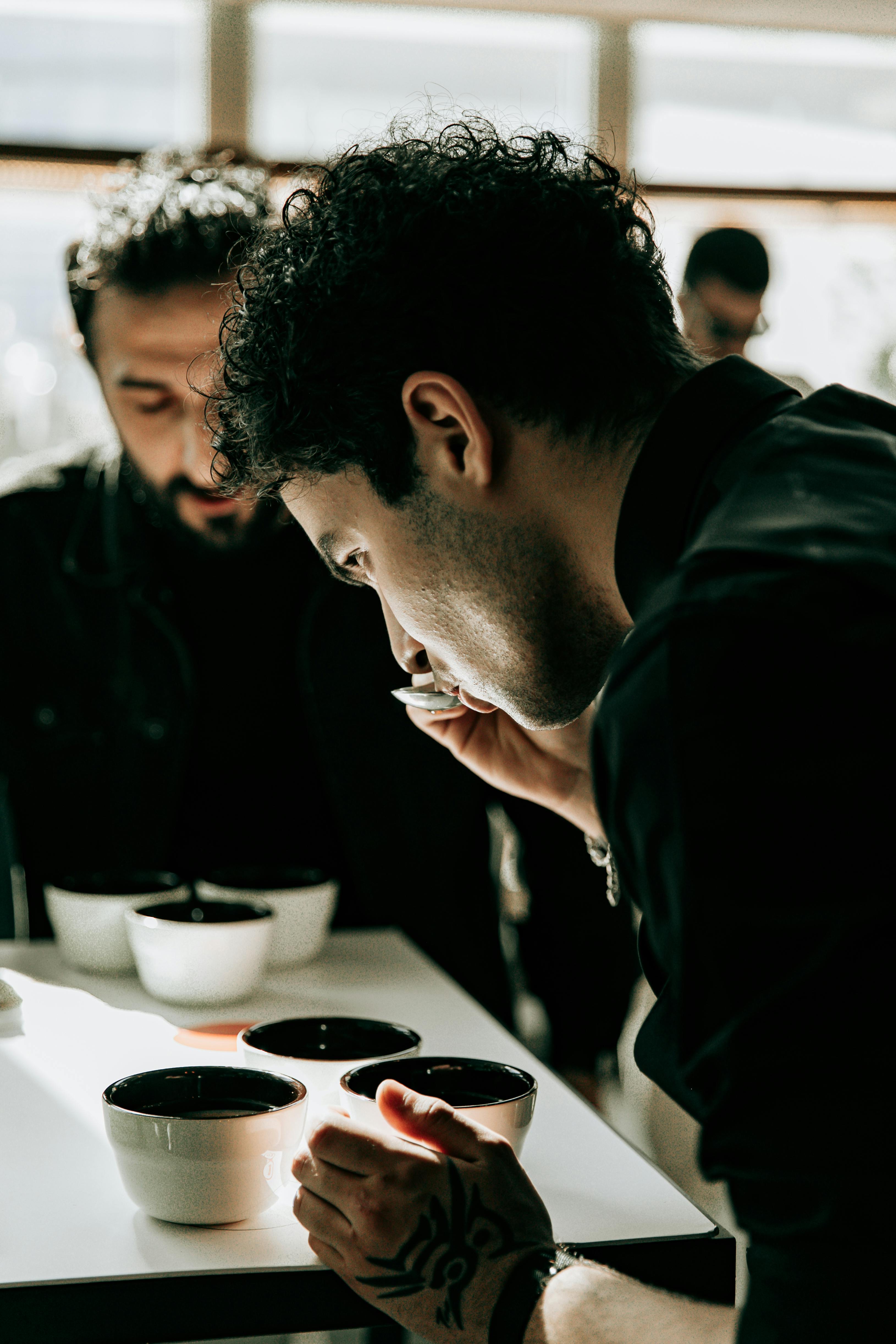 Man Sipping Coffee with a Spoon · Free Stock Photo