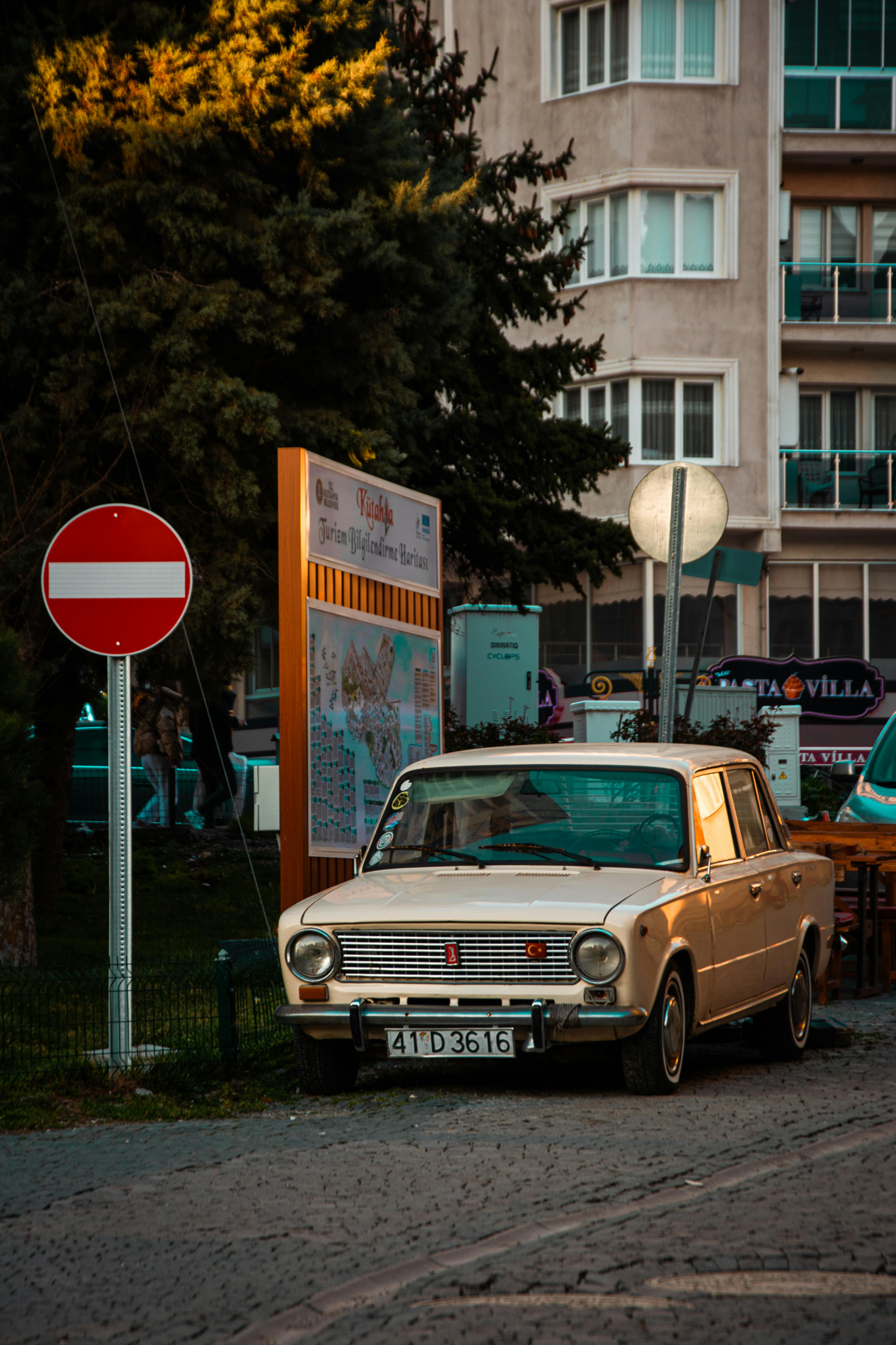 Vintage Car Parked by a Do Not Enter Sign · Free Stock Photo