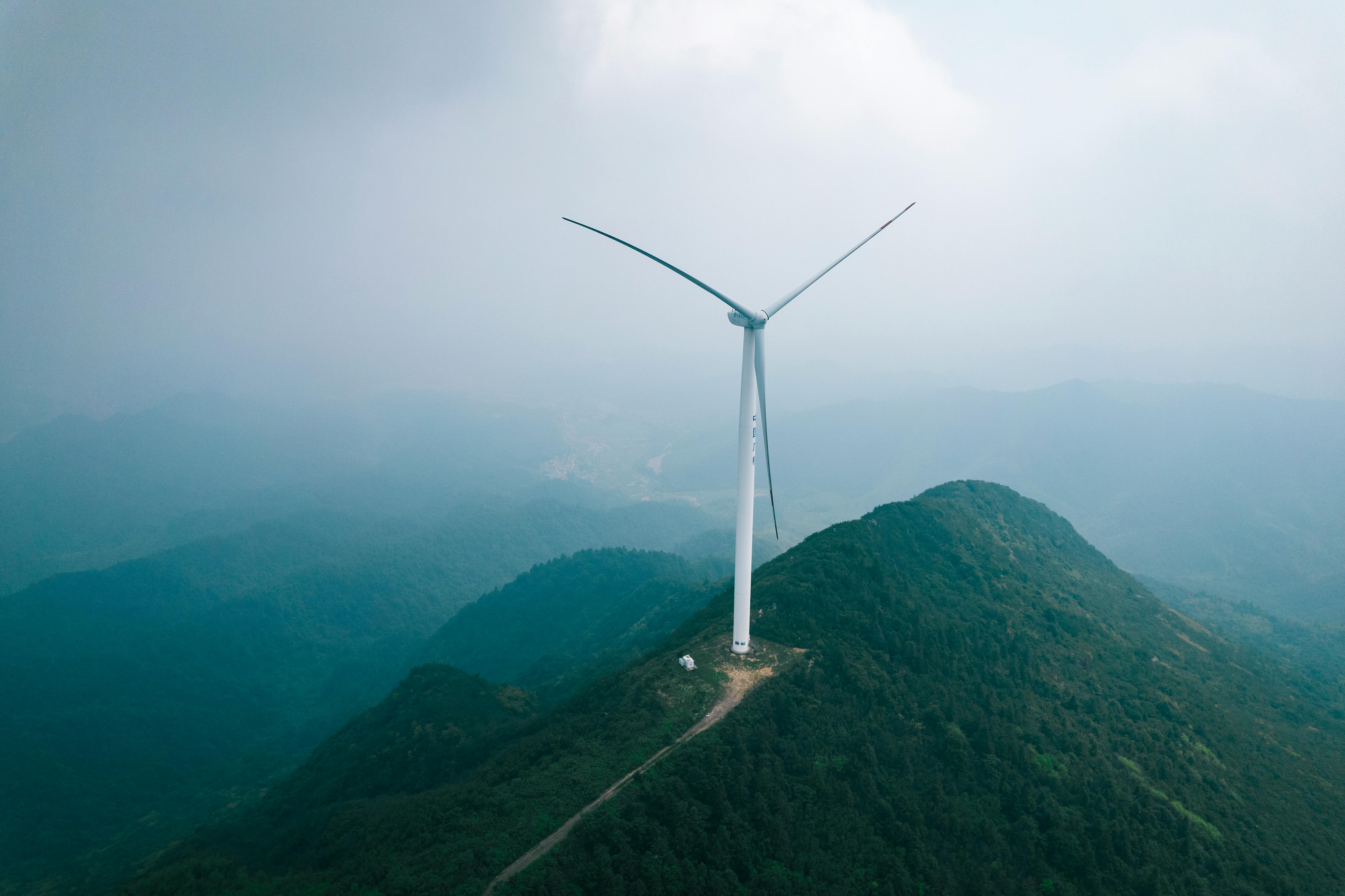 Aerial View of a Wind Turbine on Top of a Mountain · Free Stock Photo