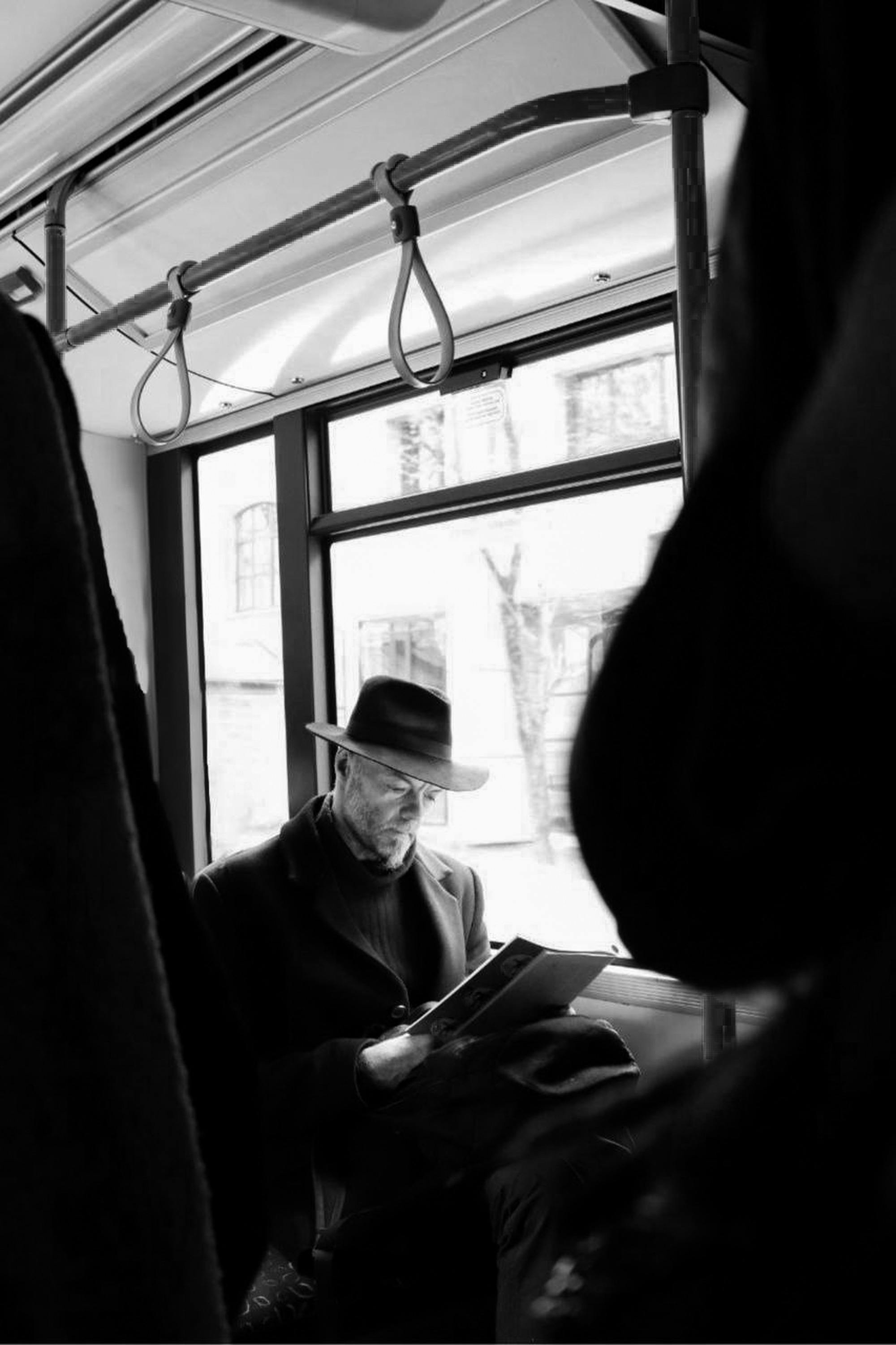 Elegant Man Reading in Bus · Free Stock Photo