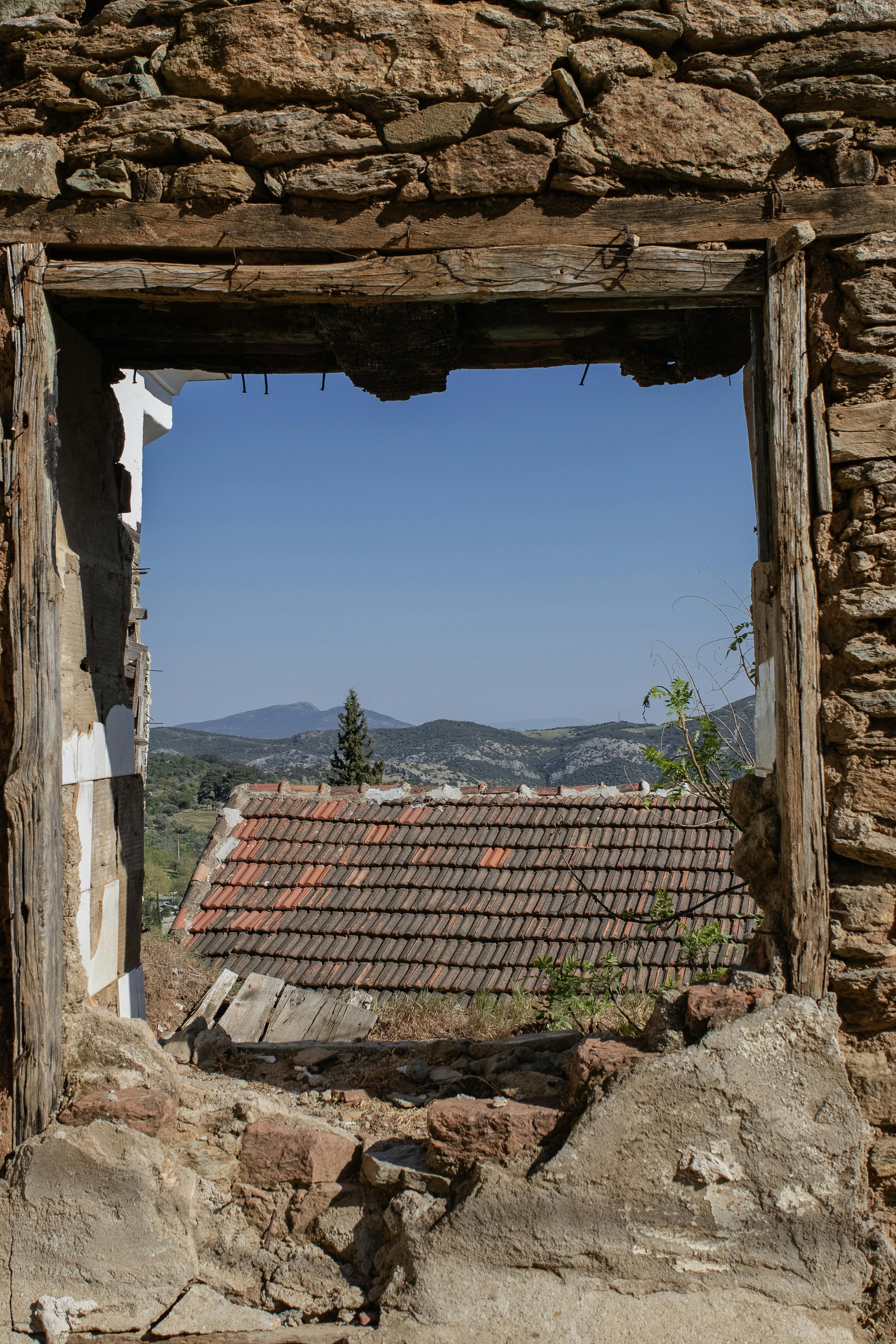 A View on a Rooftop from Ruined Window · Free Stock Photo