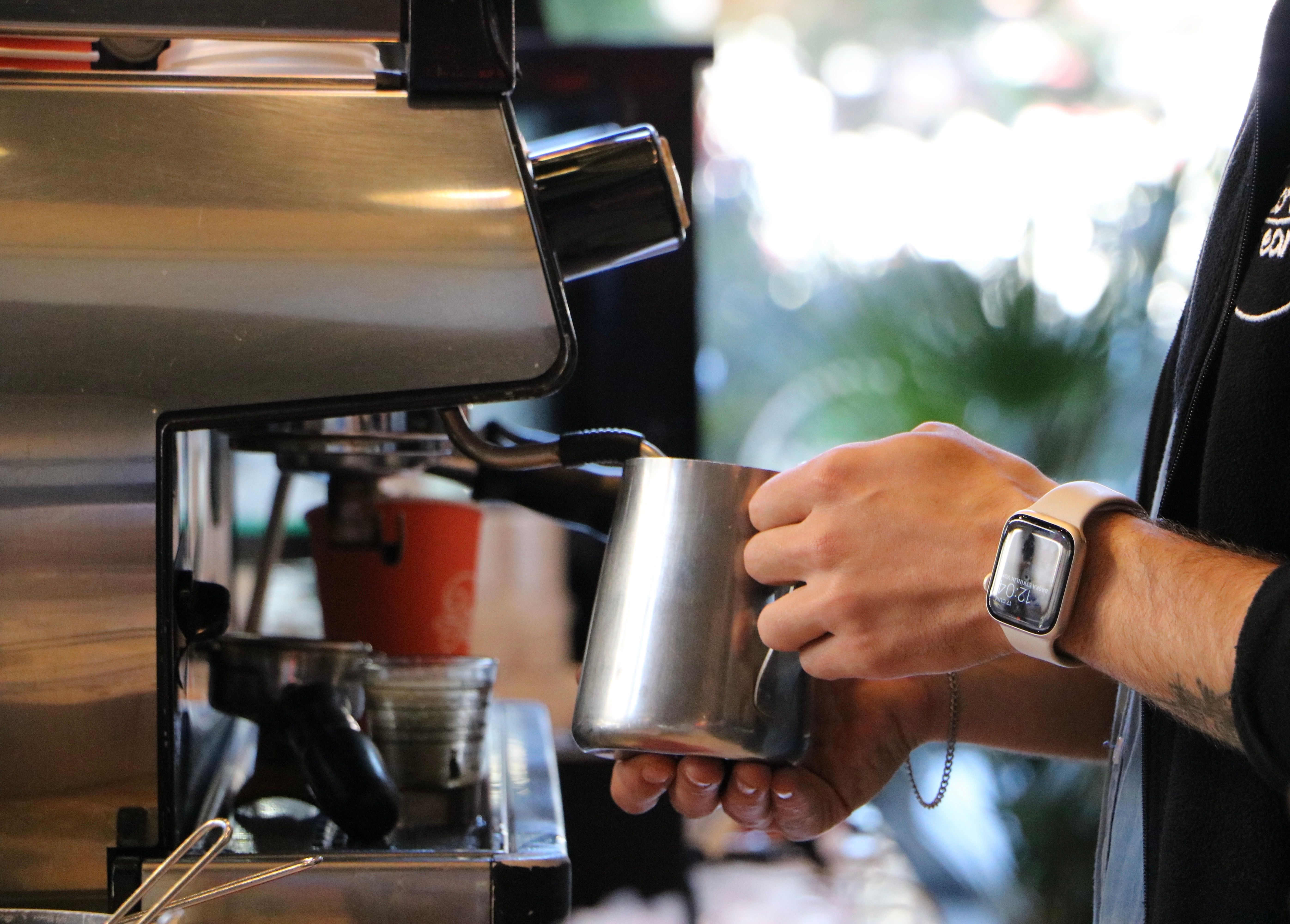 A man is pouring coffee into a cup · Free Stock Photo