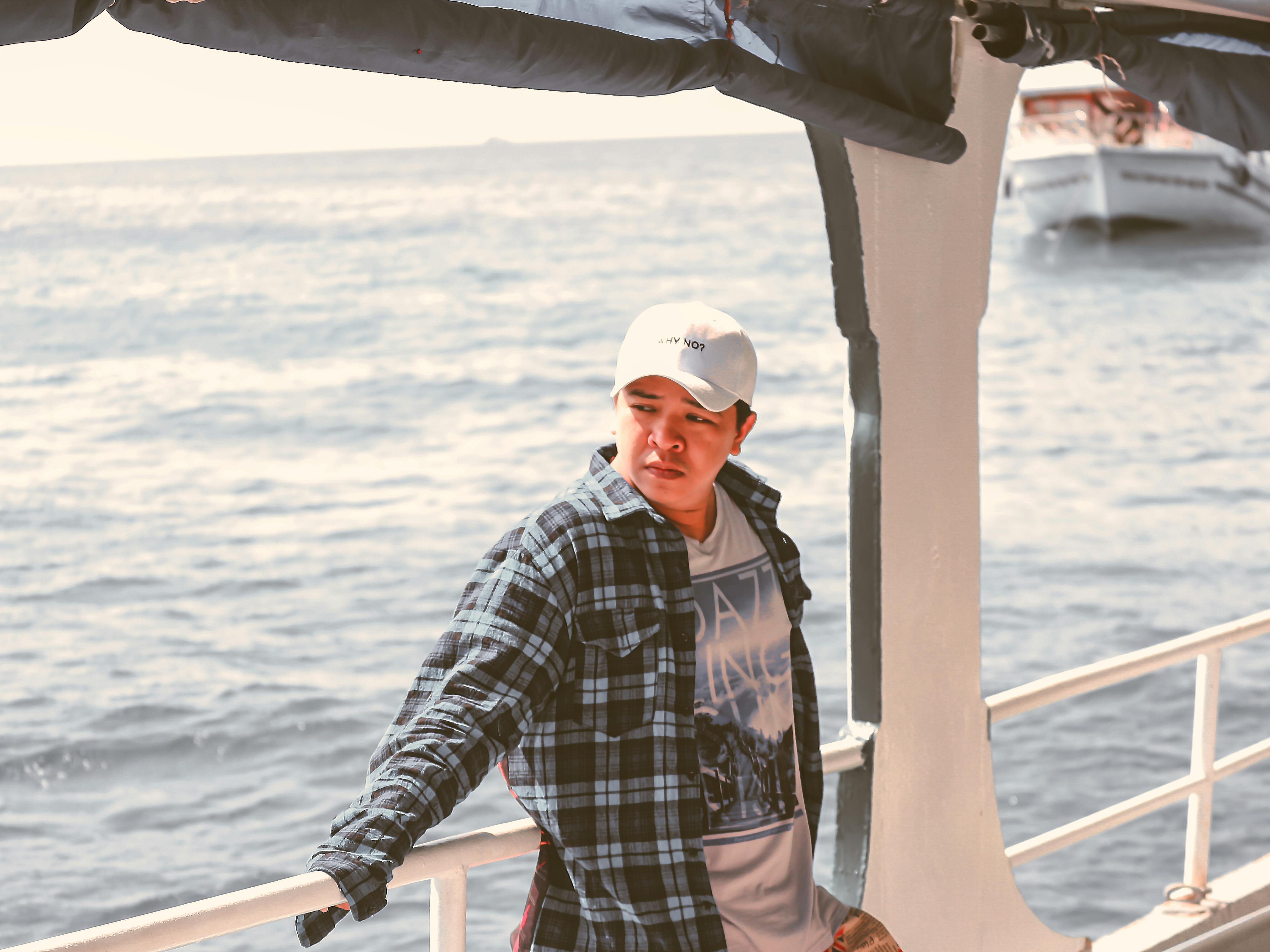 Photo Of Man Standing On Ship · Free Stock Photo