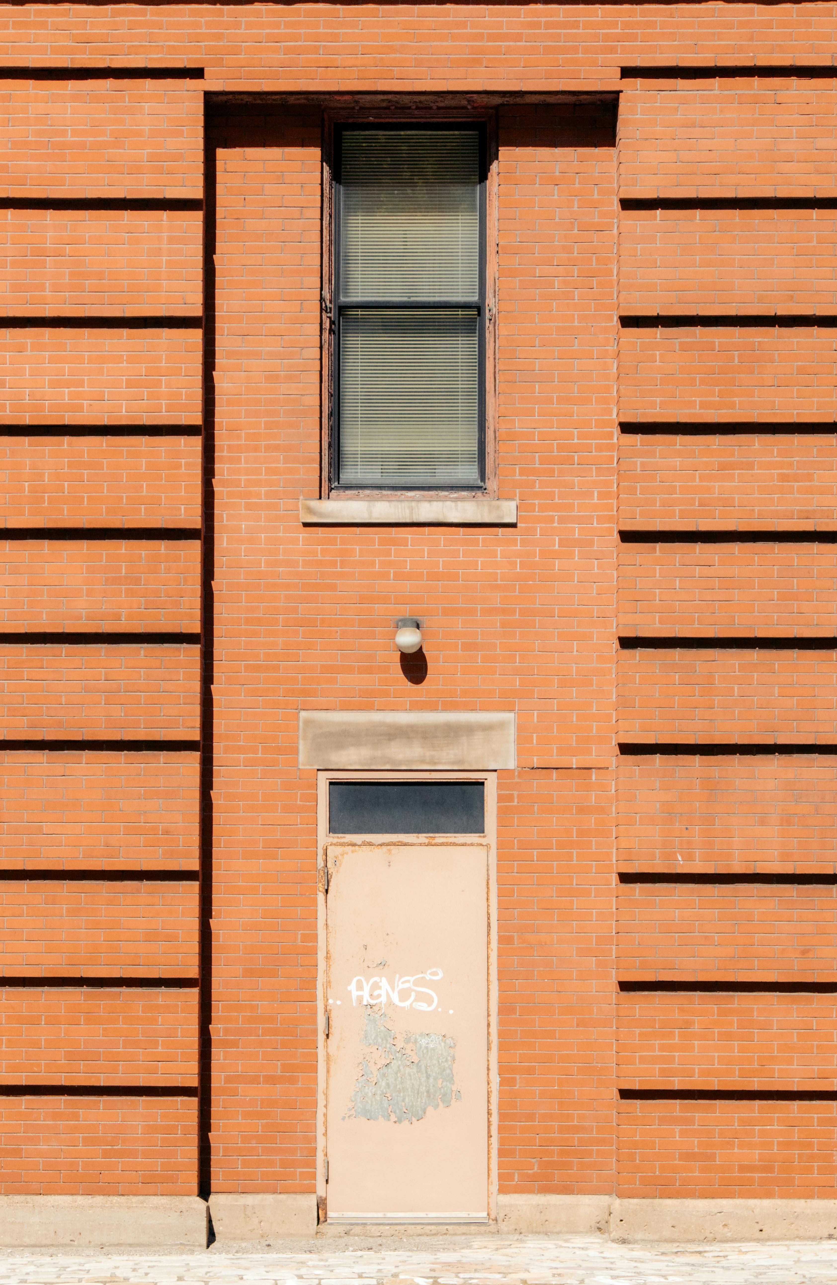 Window over Door to Brick Building · Free Stock Photo
