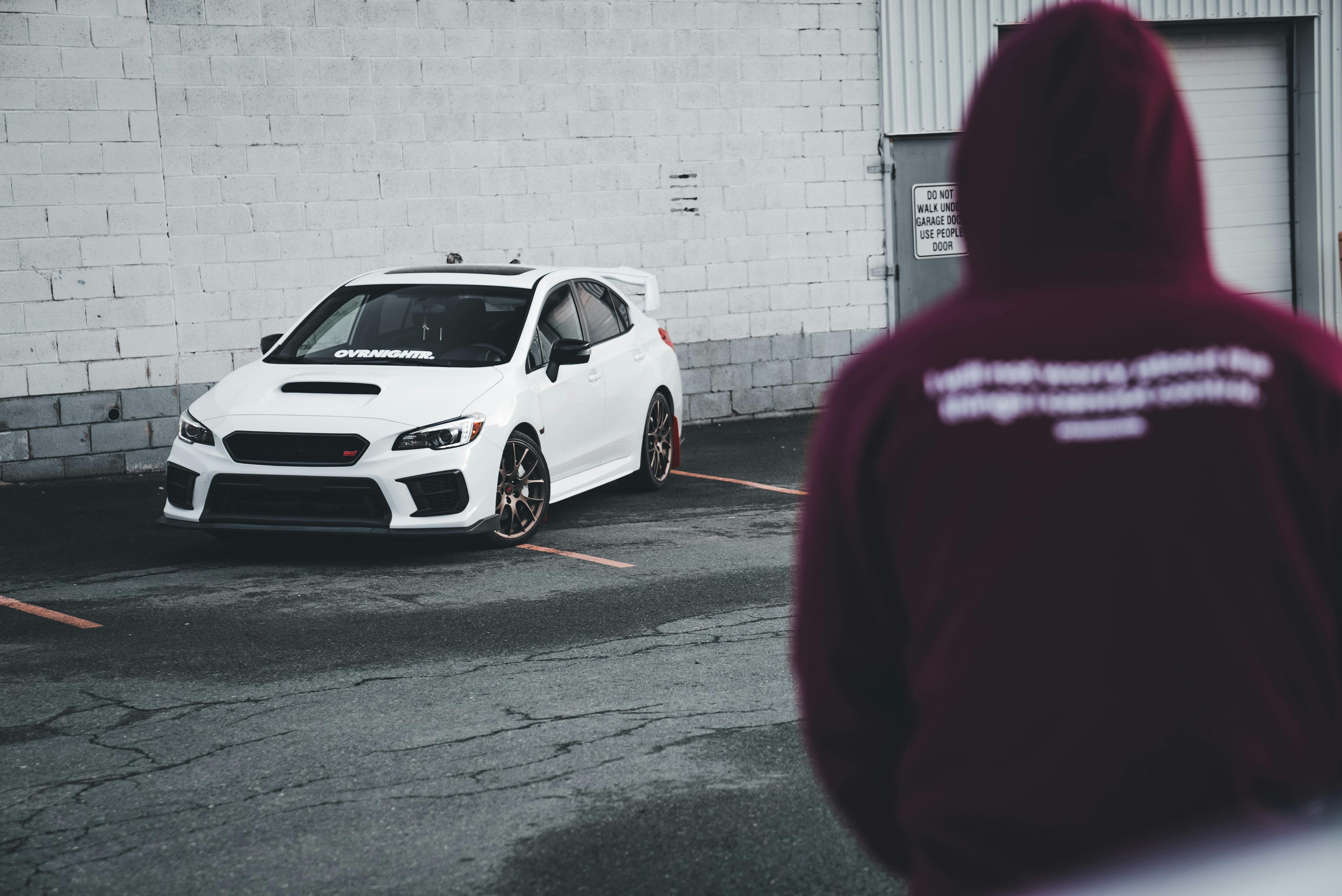 Man in Hoodie and Subaru WRX behind · Free Stock Photo