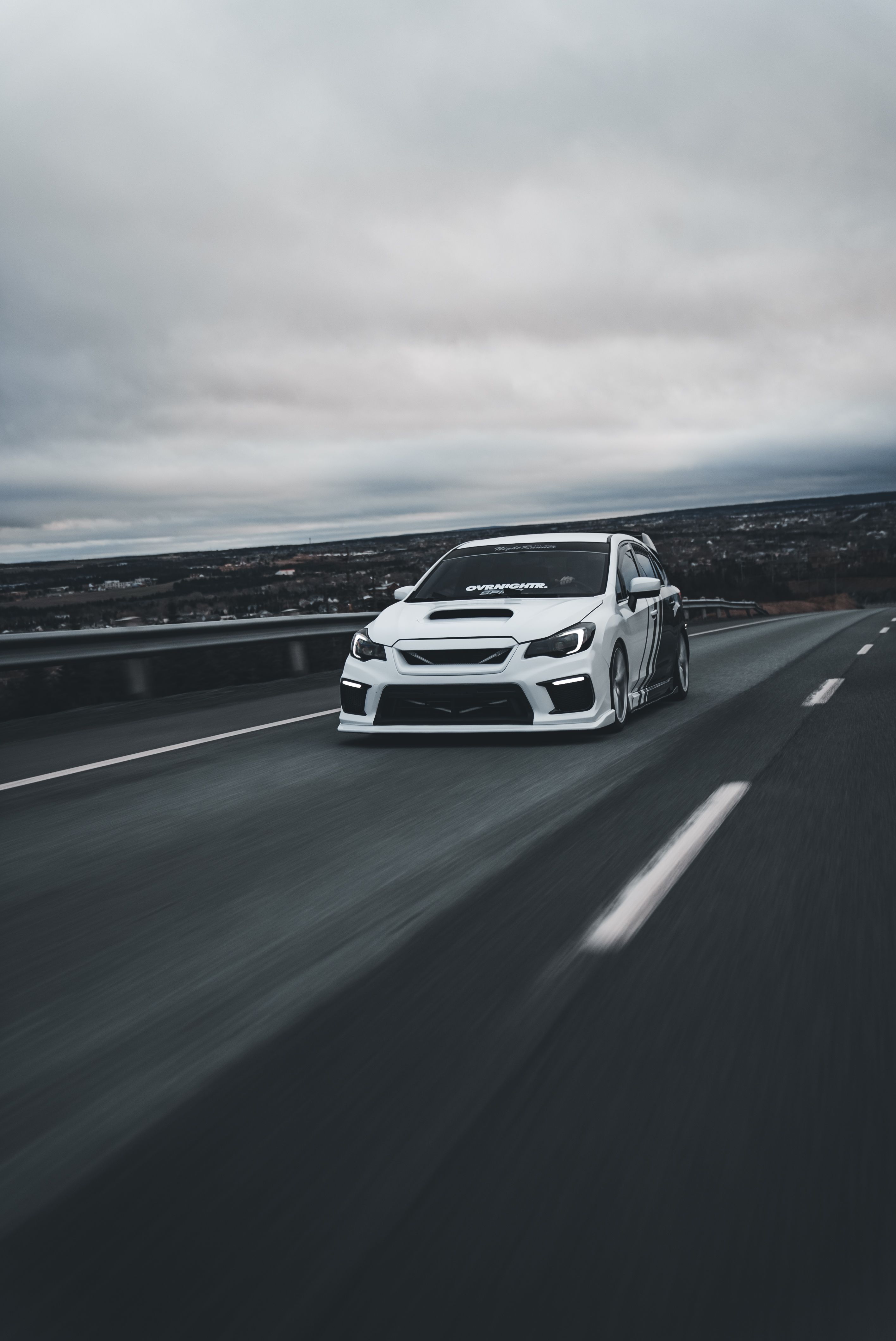 A Modified Subaru Impreza Driving on a Street · Free Stock Photo
