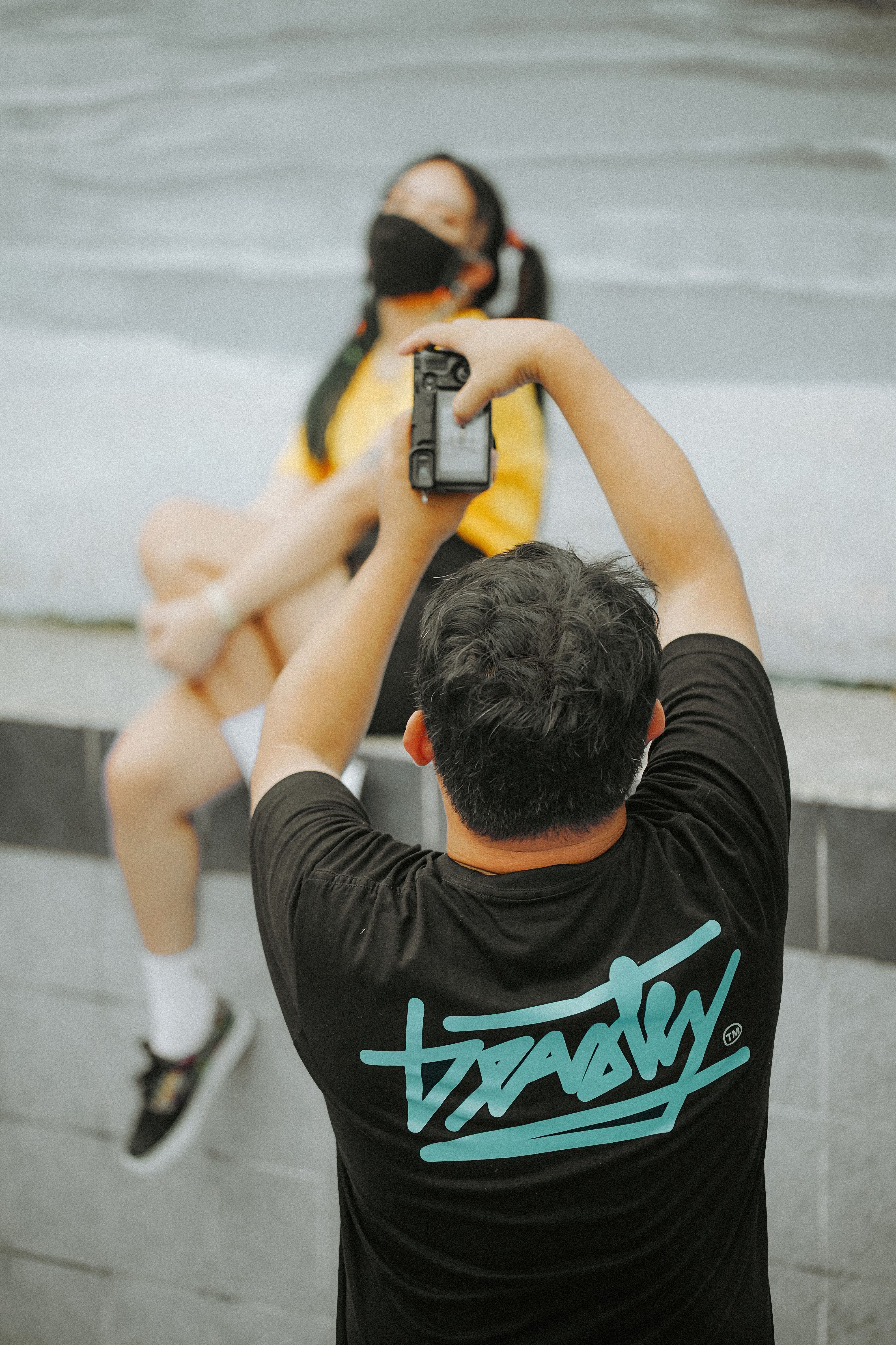 Man Photographing a Model in a Yellow T-Shirt · Free Stock Photo