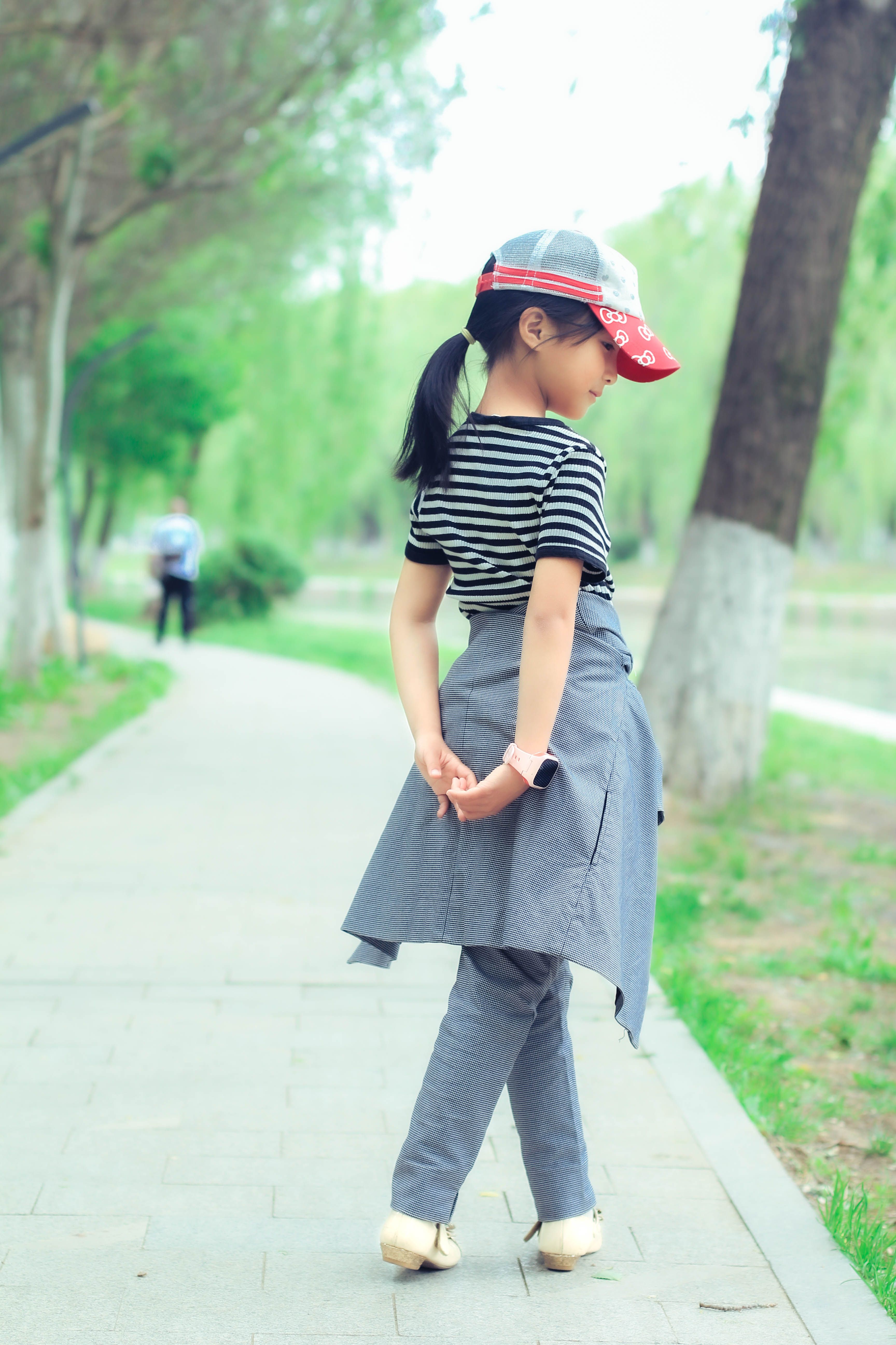 Girl Standing on Sidewalk at Park · Free Stock Photo