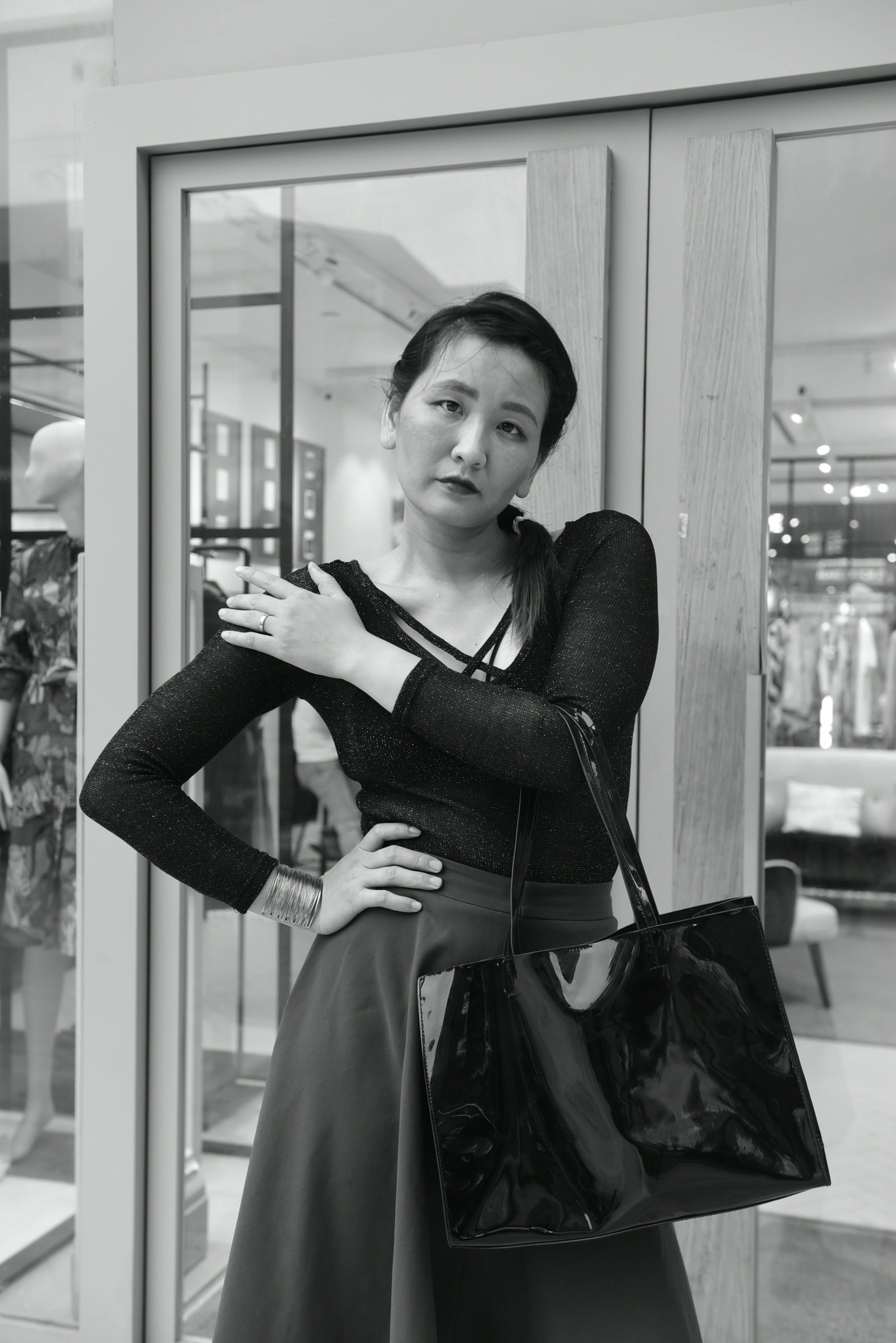 Black and White Photo of a Fashionable Woman Standing in a Clothing ...