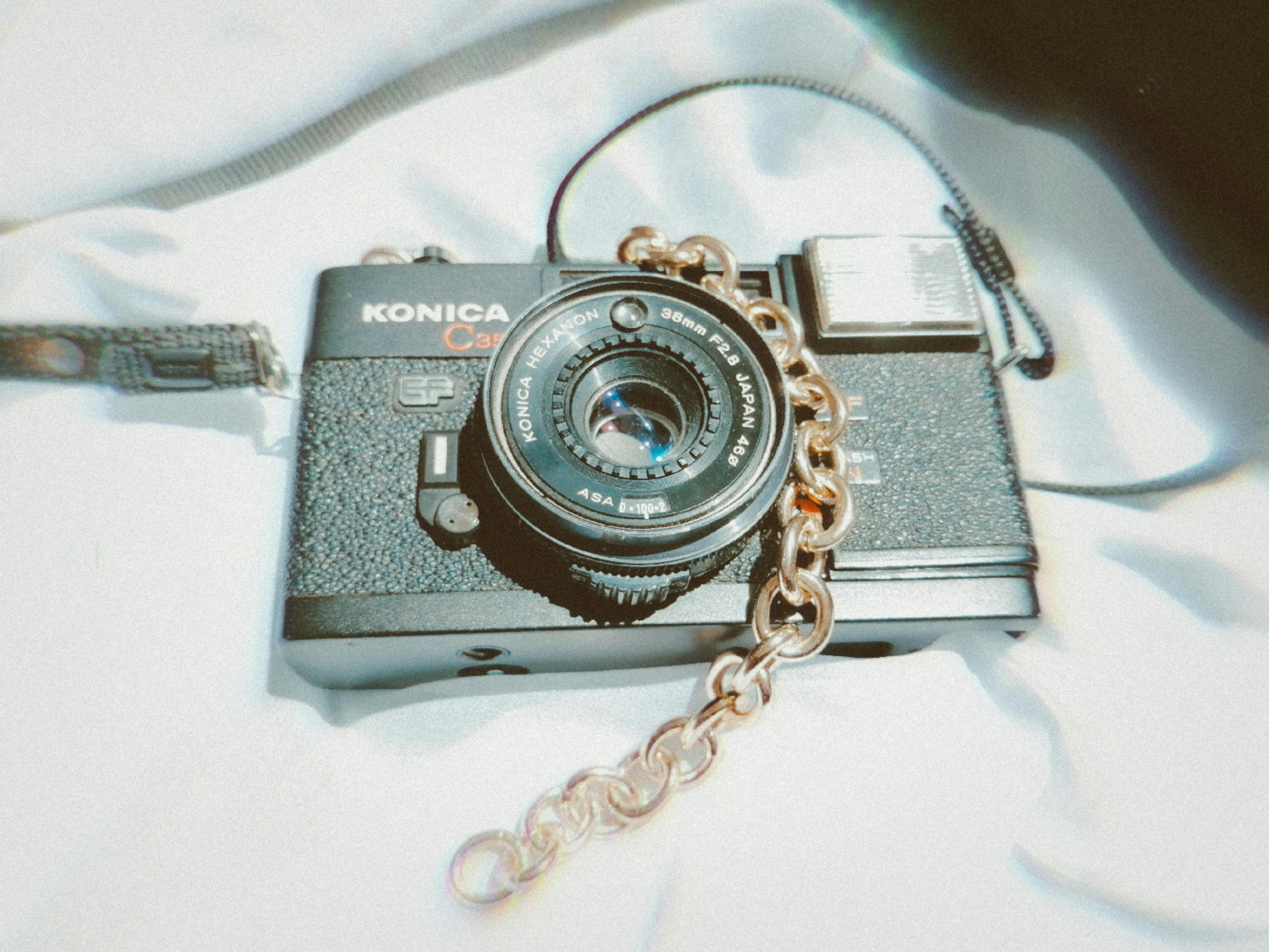 Konica Camera on White Sheets · Free Stock Photo