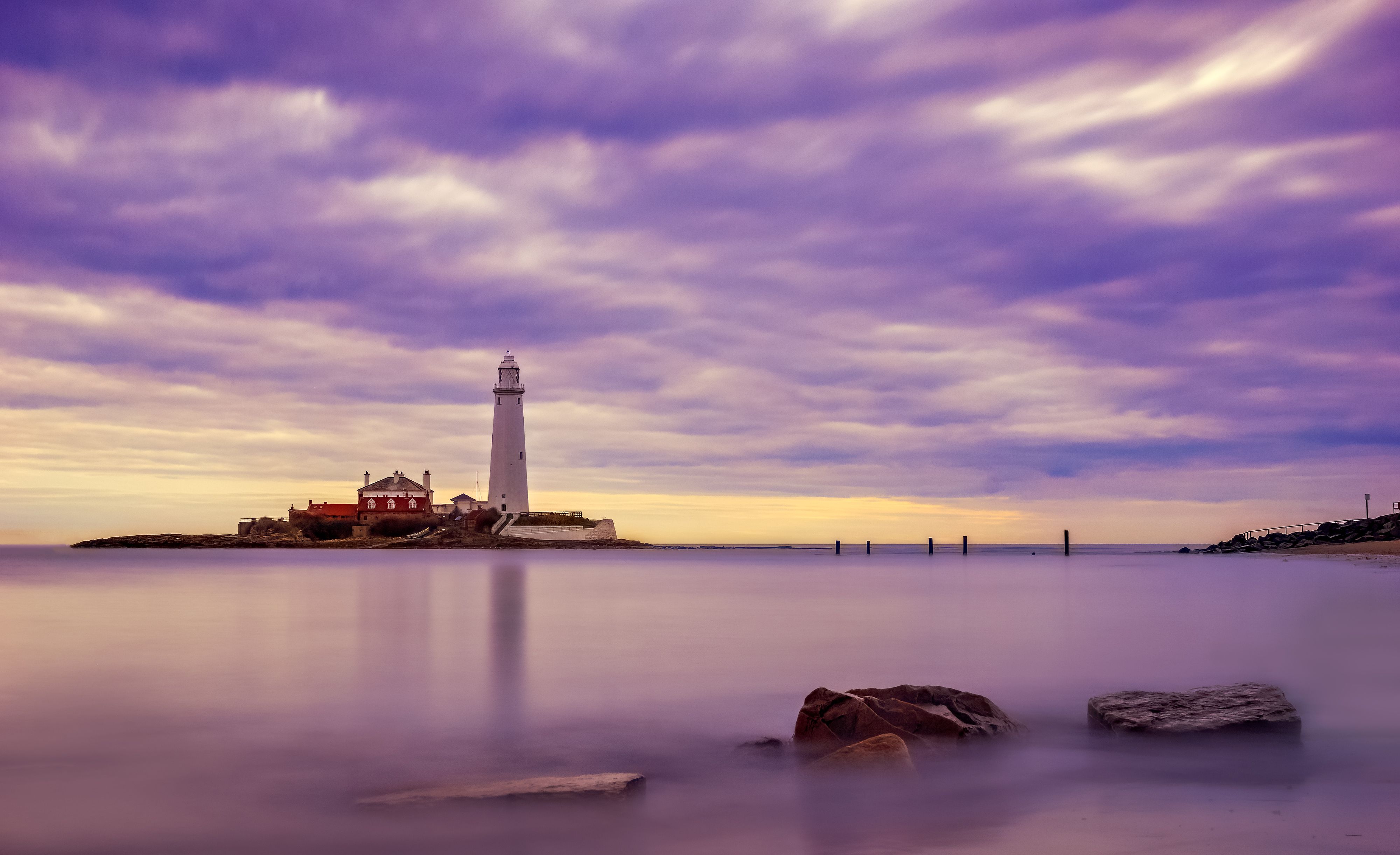 A purple sky with clouds and a lighthouse · Free Stock Photo