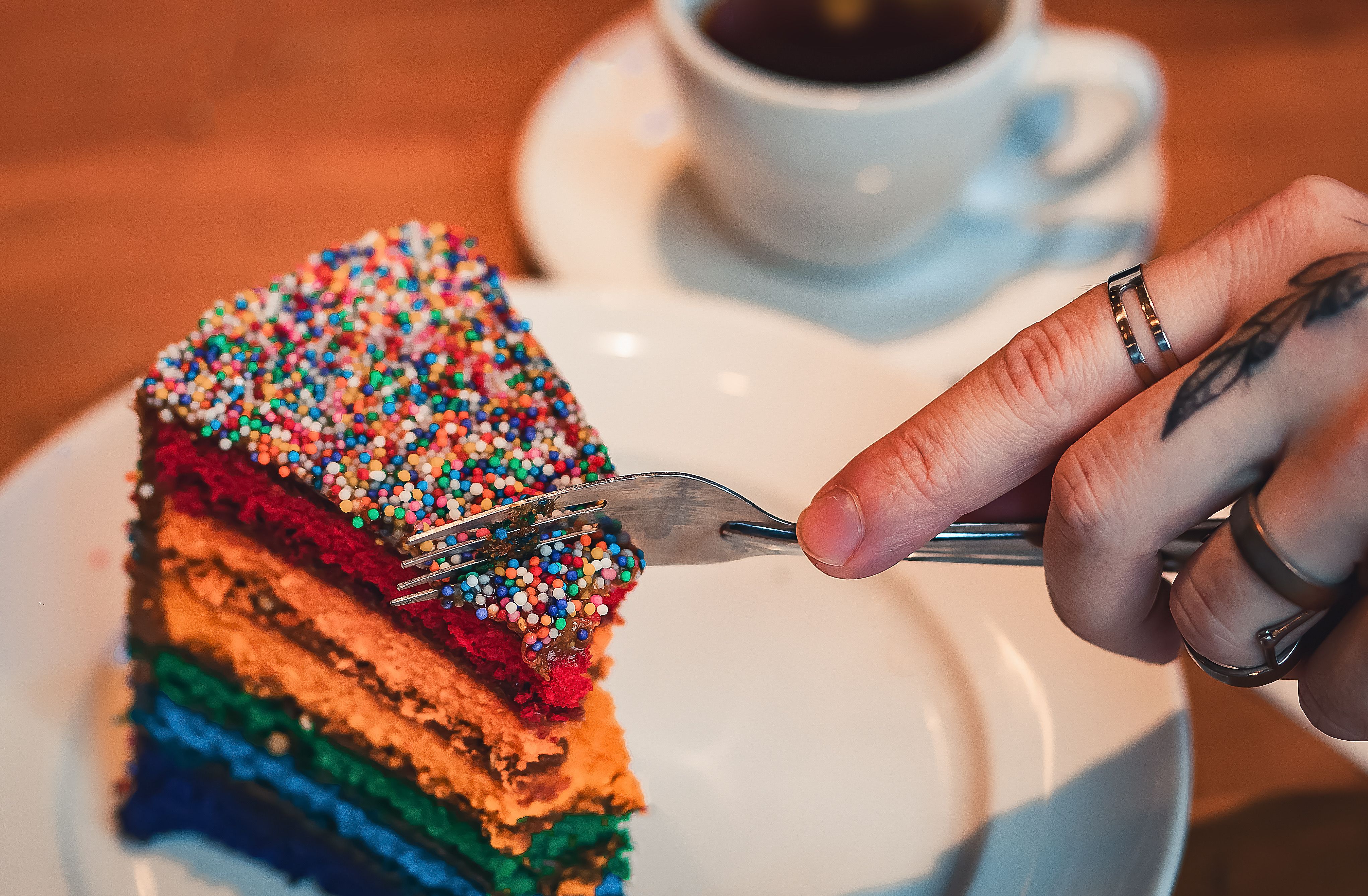 Person Taking a Piece from a Colorful Cake · Free Stock Photo