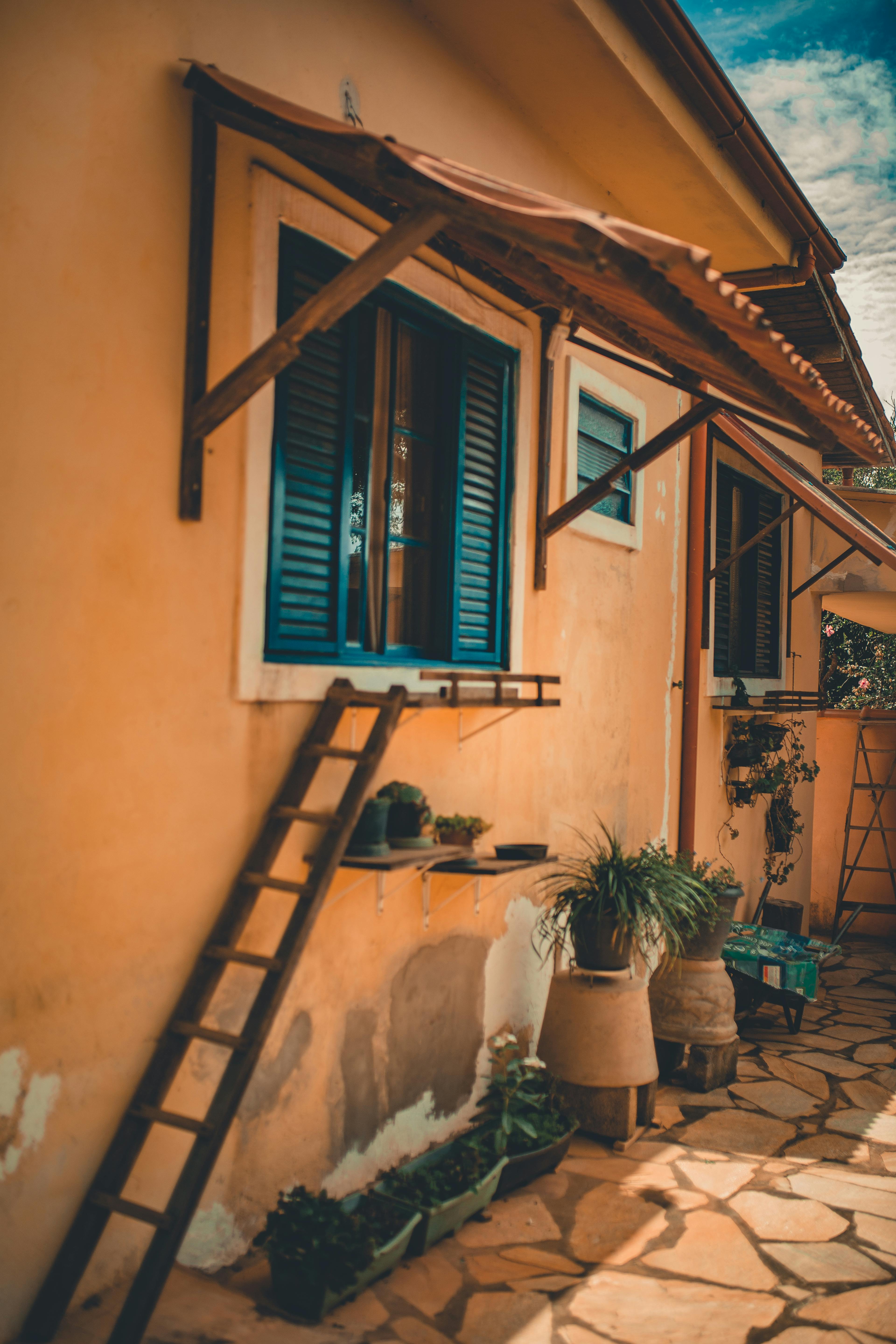 Ladder Leaning Near Window · Free Stock Photo