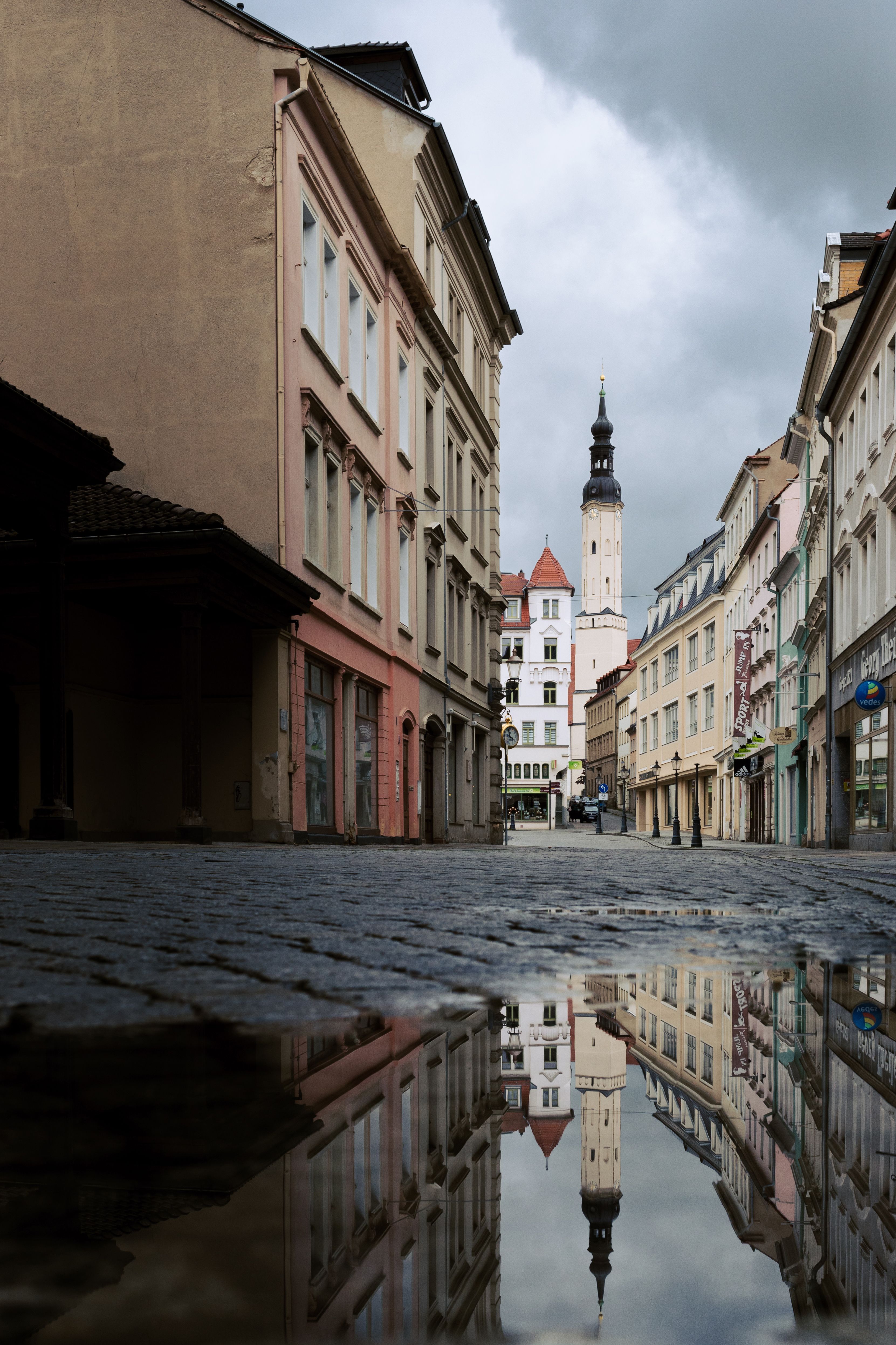 A puddle on the street in a city · Free Stock Photo