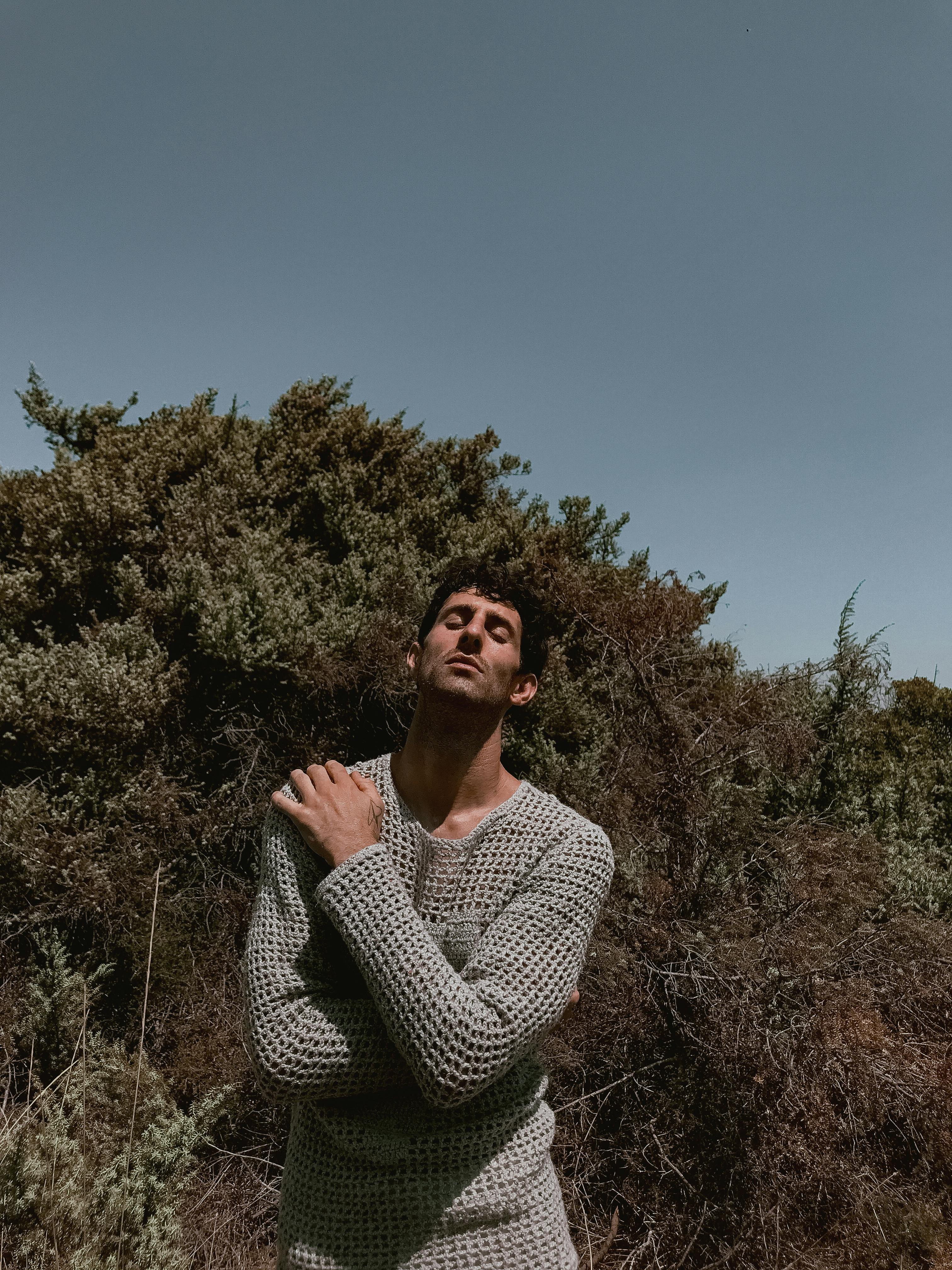 Man Posing Among Shrubs · Free Stock Photo