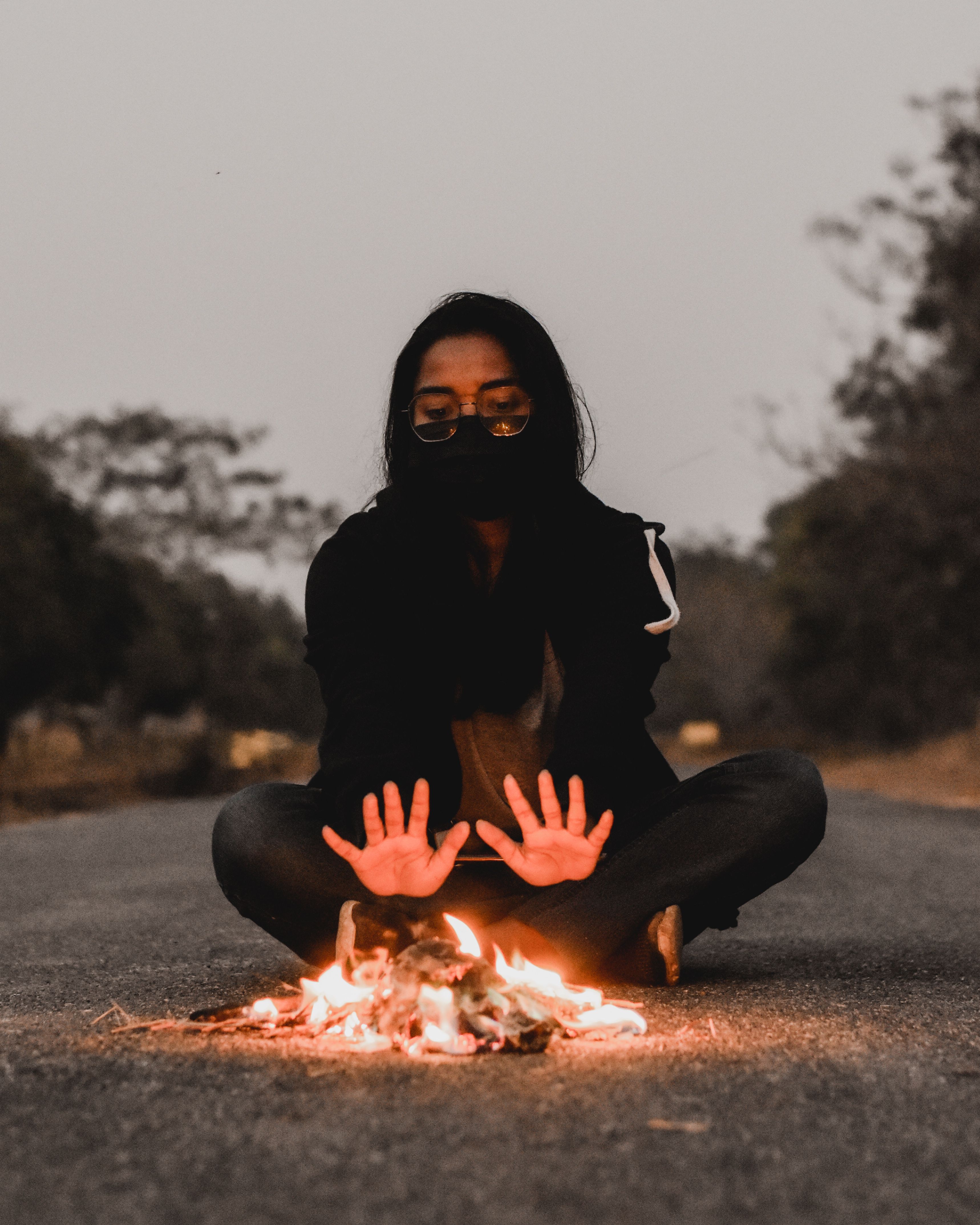 Woman Sitting by Fire · Free Stock Photo
