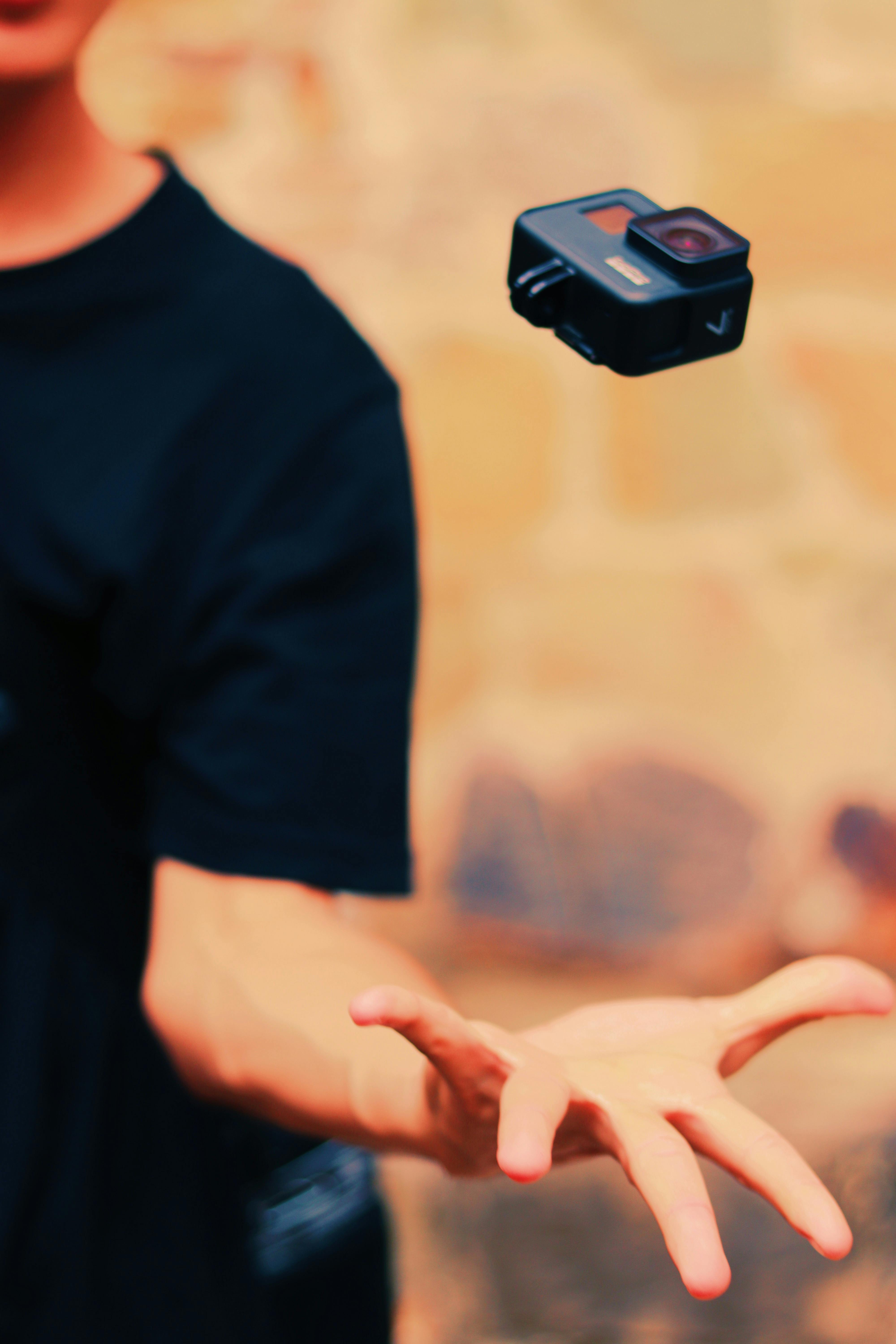 Person Catching Black Action Camera · Free Stock Photo