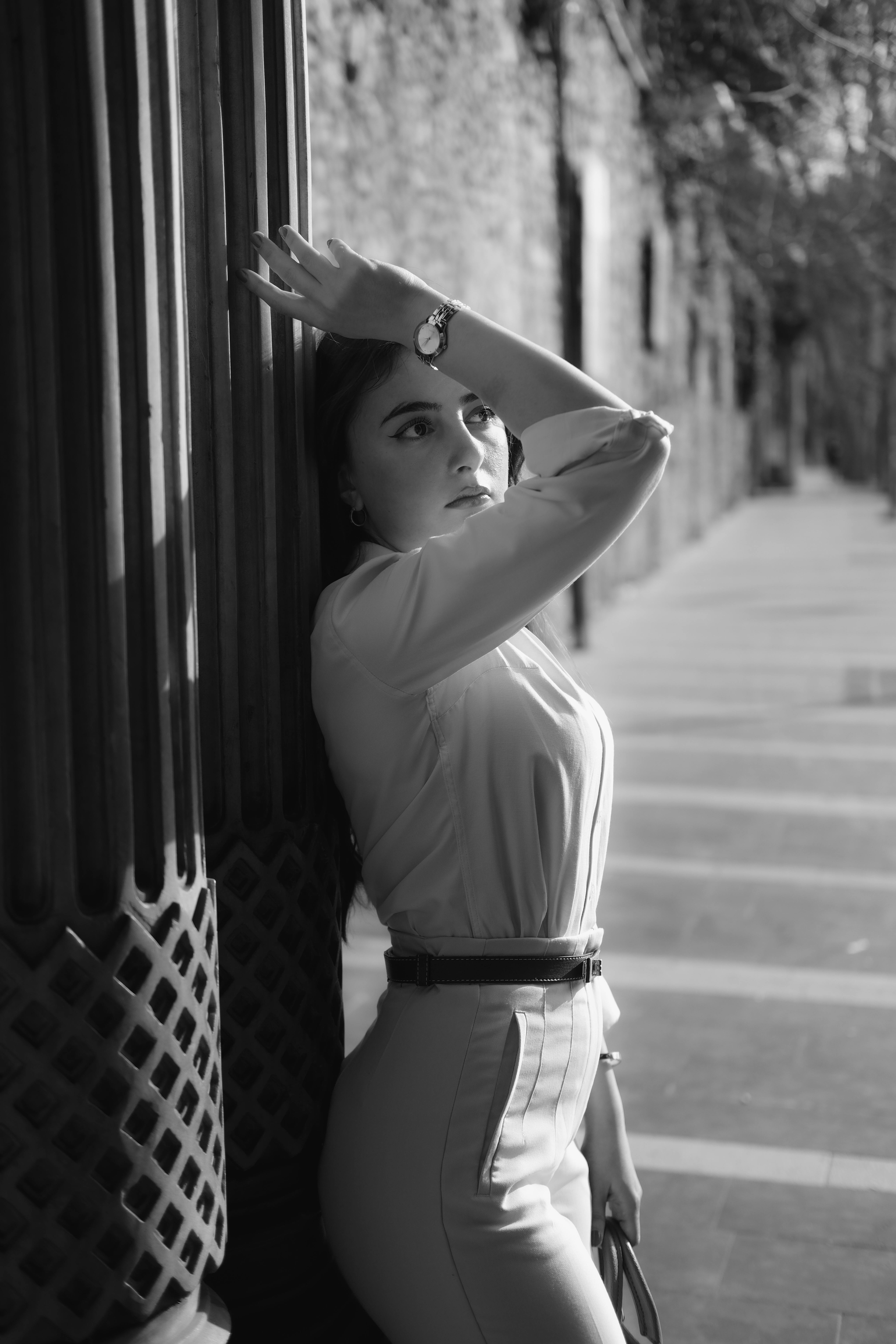 Beautiful Woman in Shirt Posing by Pillar on Street · Free Stock Photo