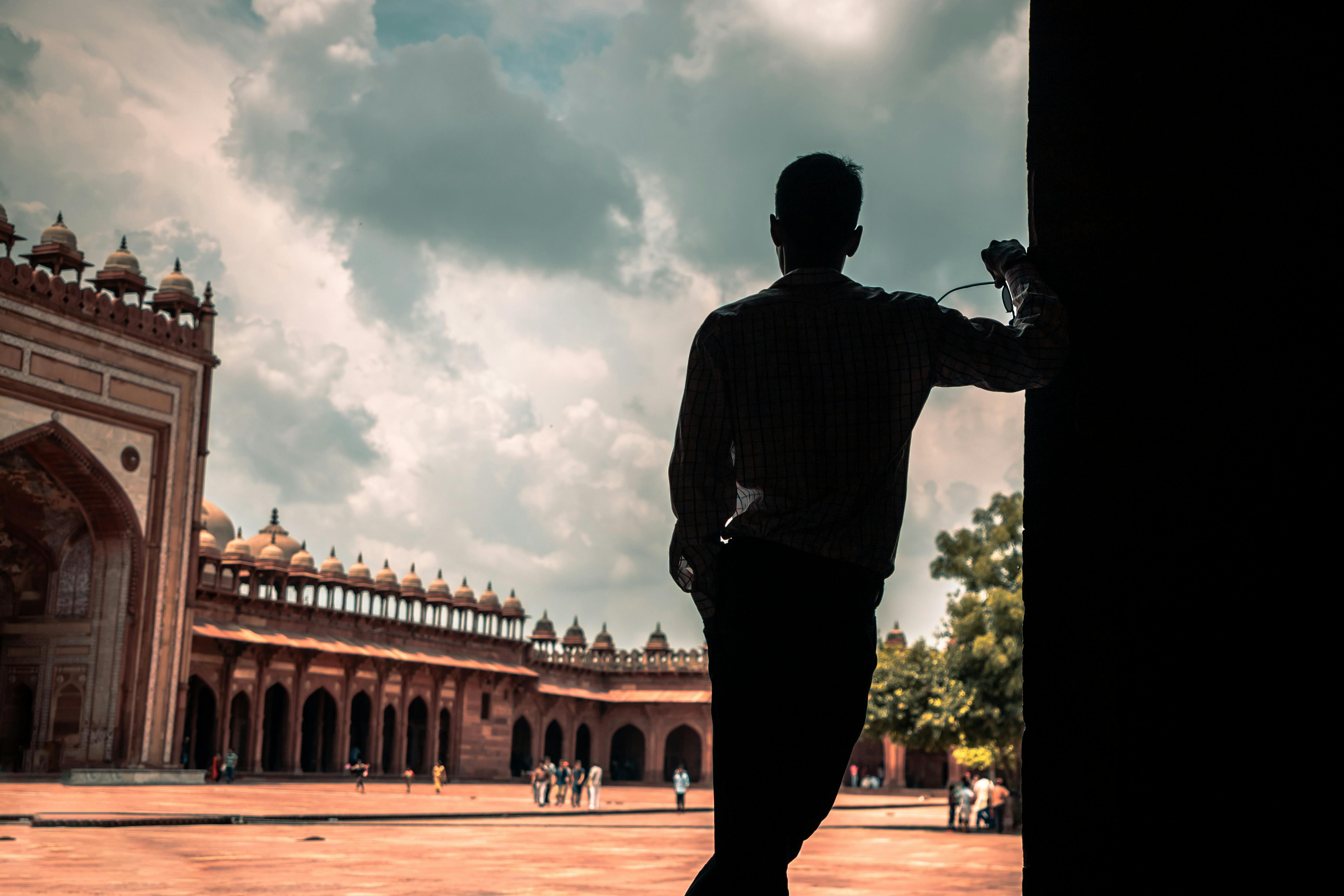 Silhouette of a Man Standing Near Building · Free Stock Photo