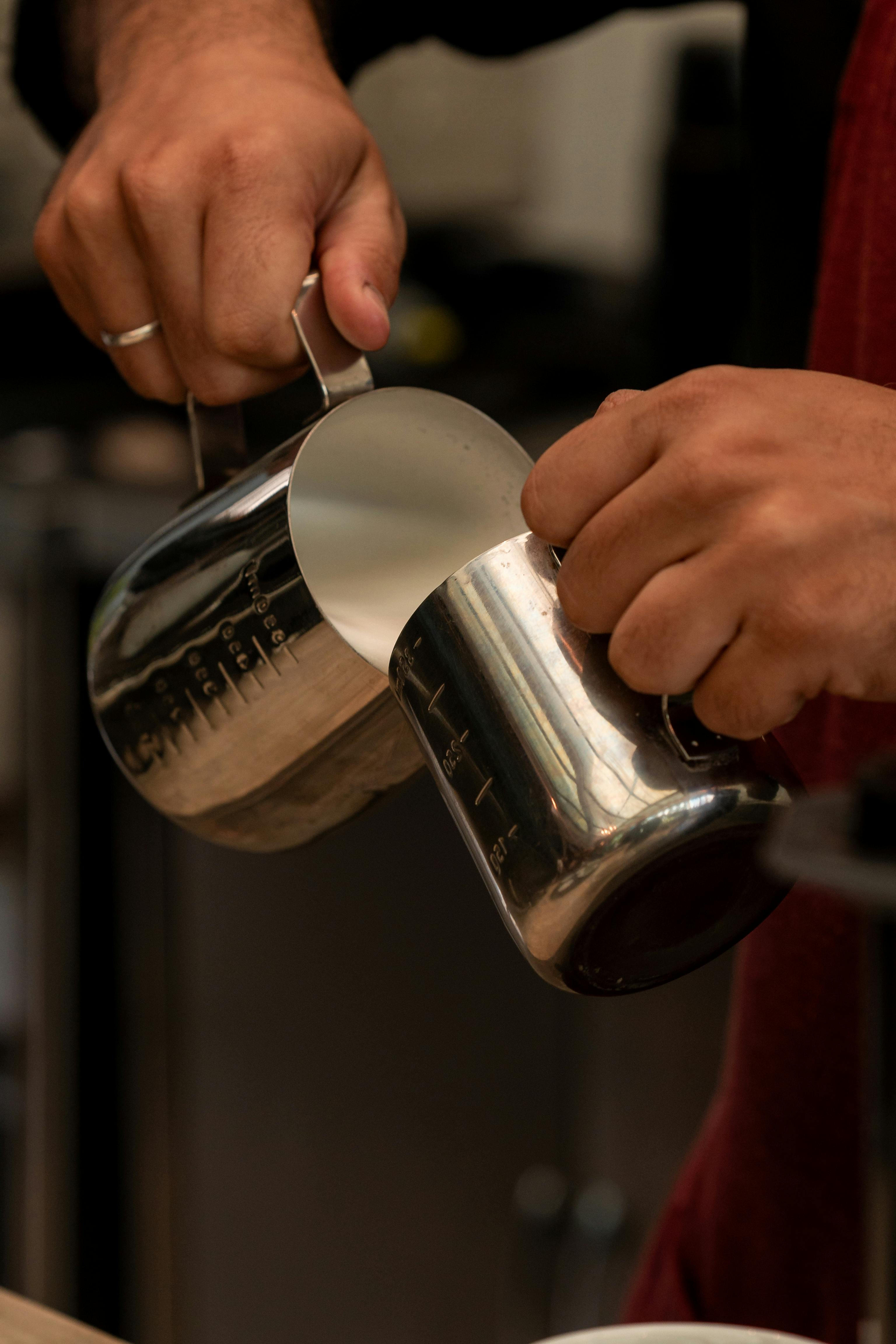 Barista Hands Holding Pitchers with Milk · Free Stock Photo