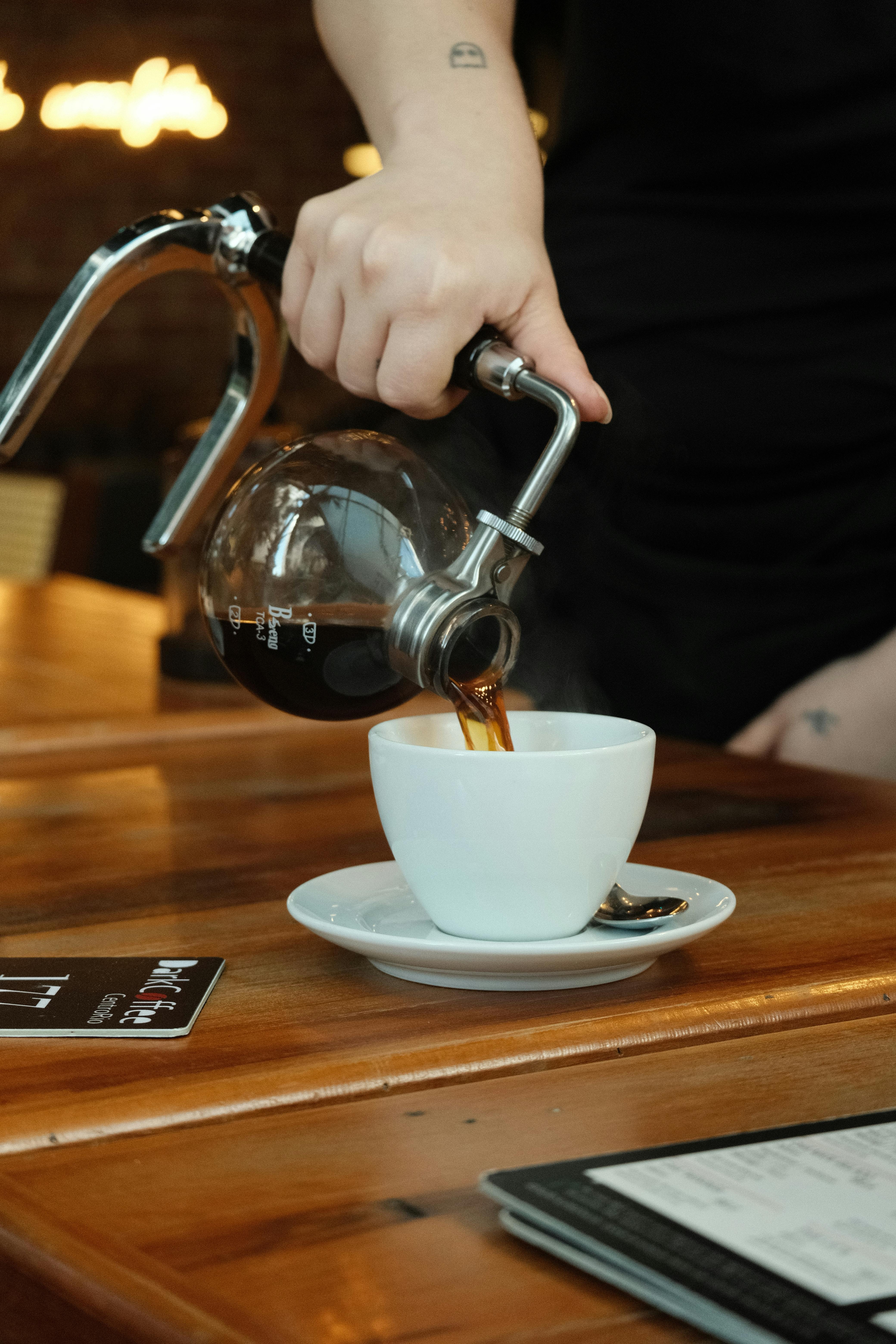 Barista Hand Pouring Coffee · Free Stock Photo