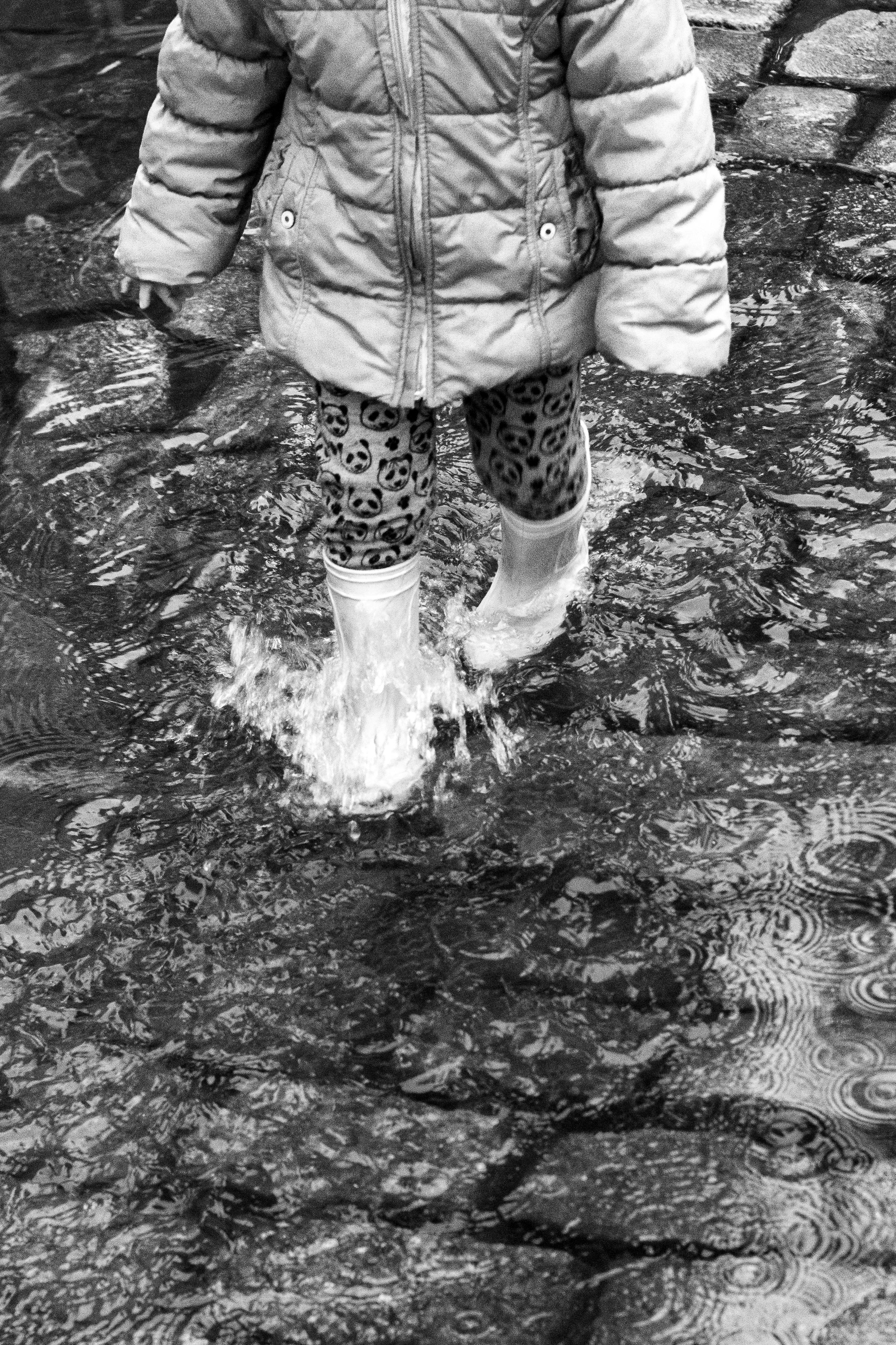 Child Walking in Puddle · Free Stock Photo