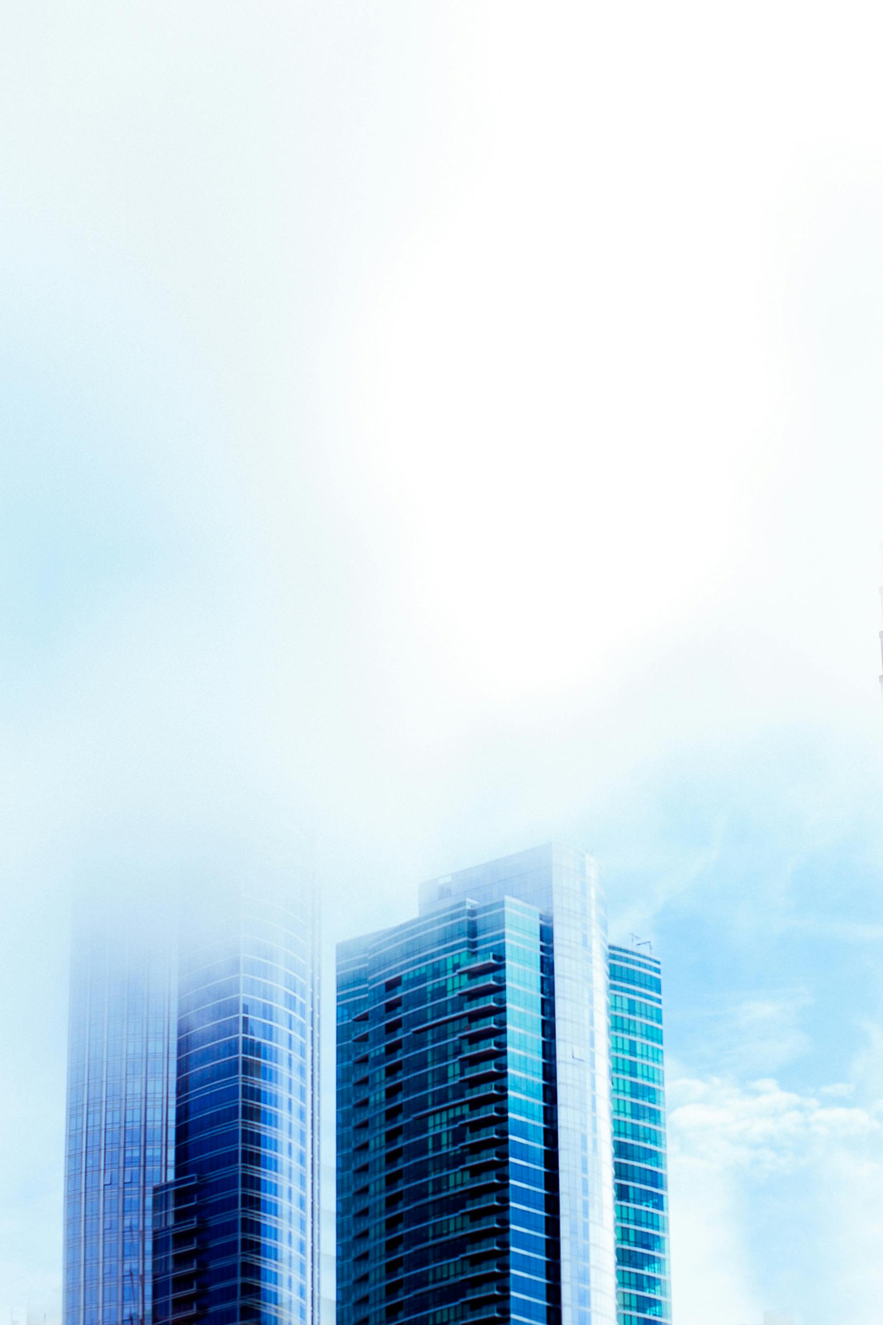 Low-angle Photography of Buildings Covered by Fog · Free Stock Photo
