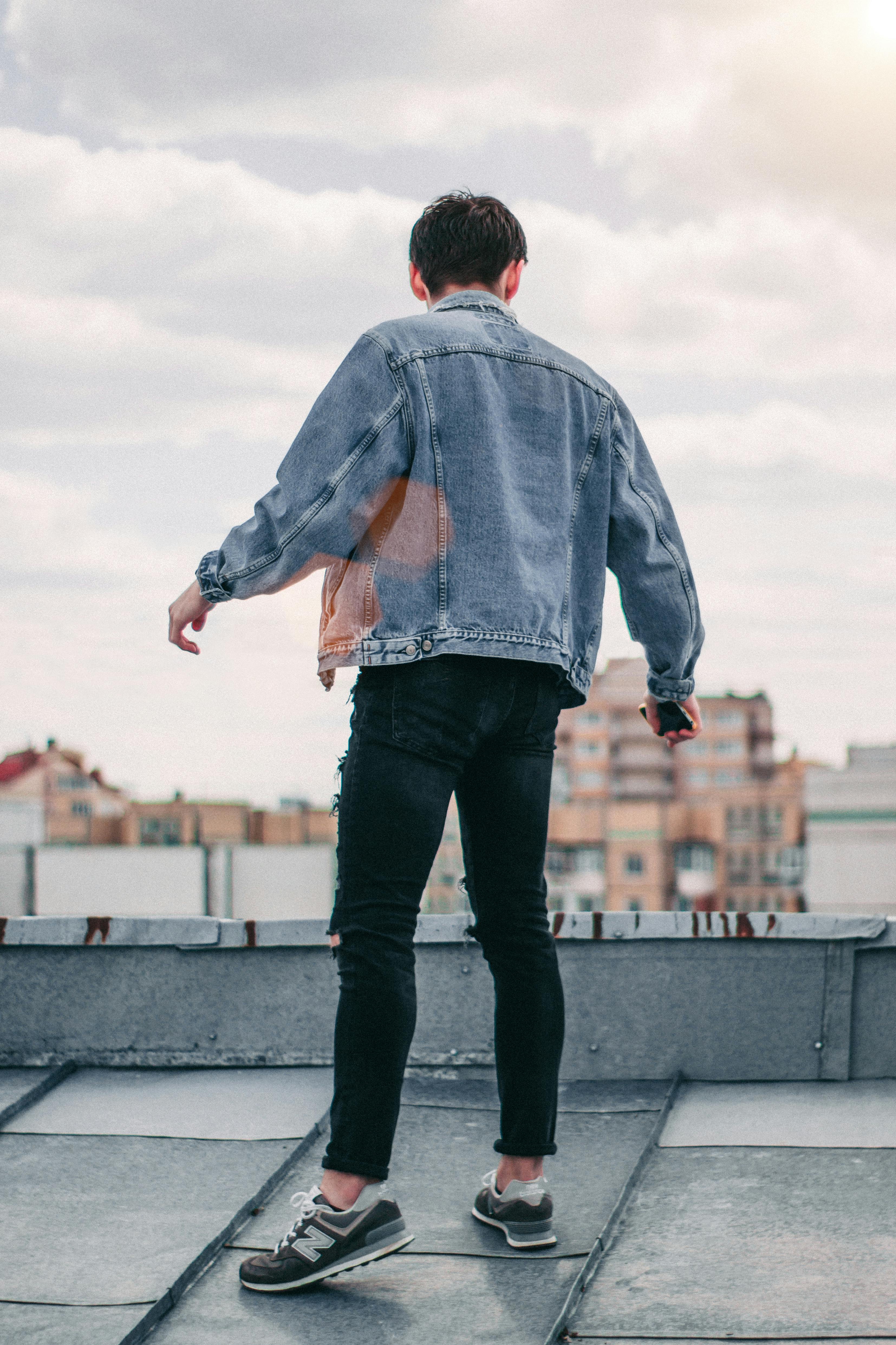 Photo of a Person Standing on Rooftop · Free Stock Photo