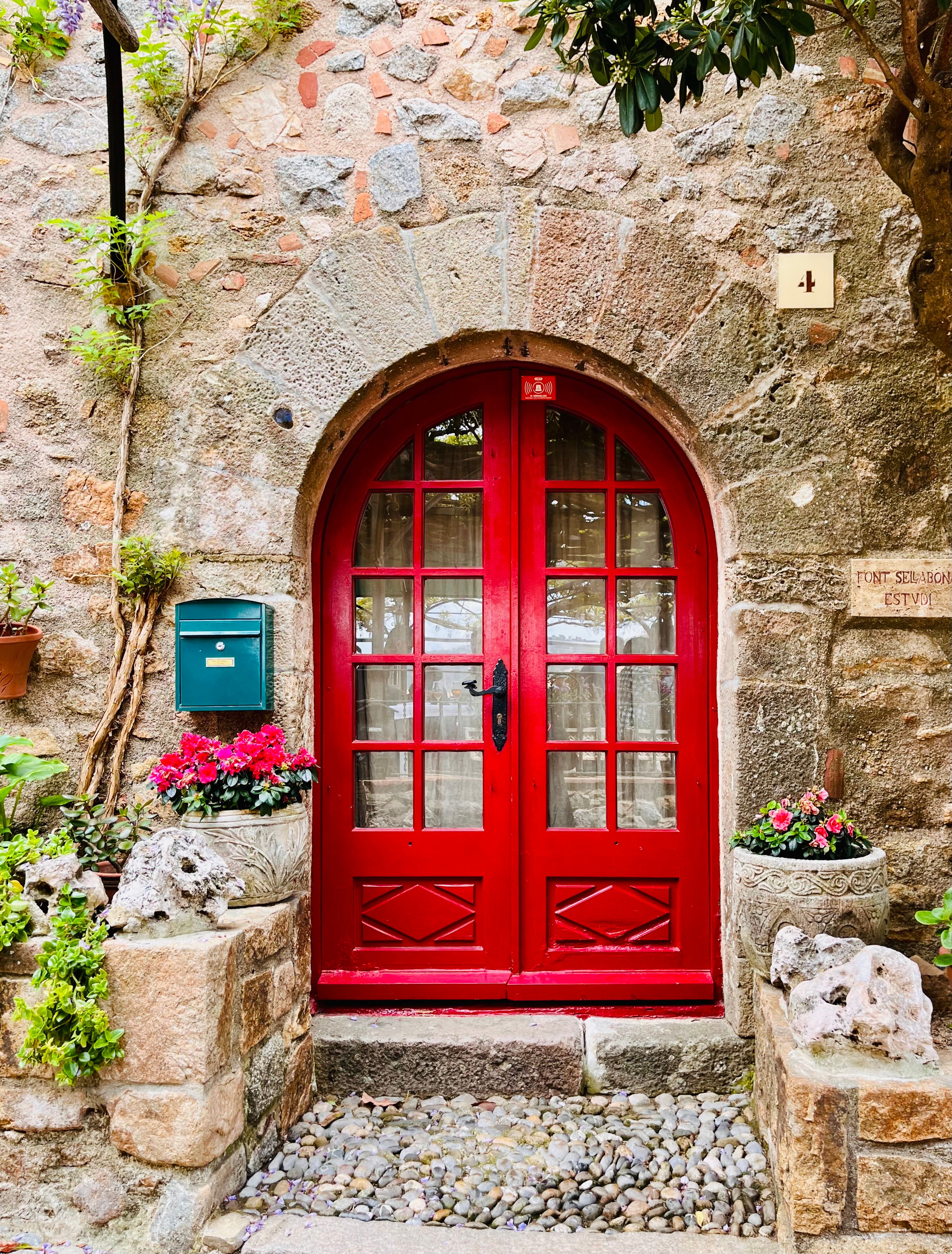 Red Entrance Doors to Dreamy Stone Building · Free Stock Photo