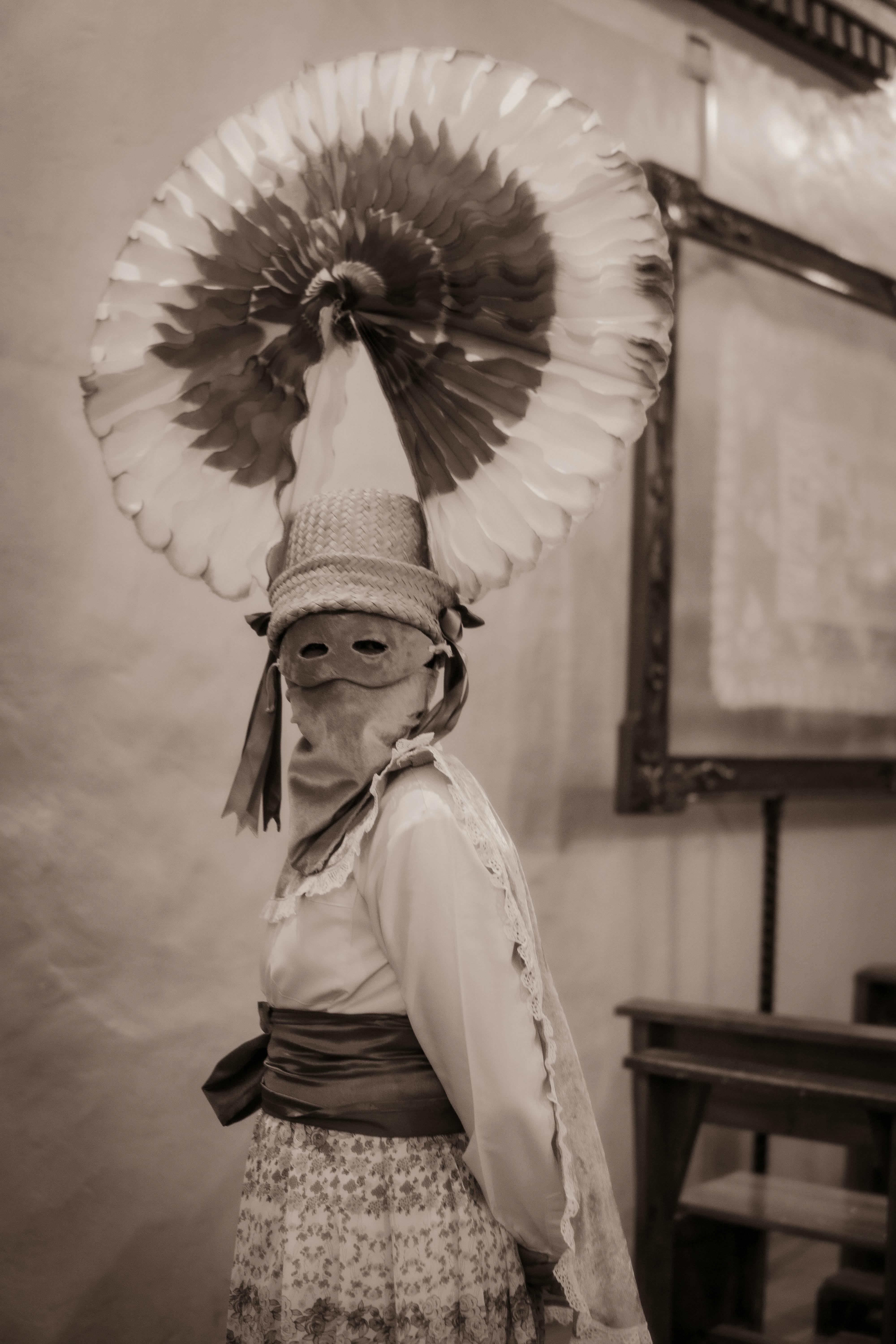 Sepia Toned Photo of Person in Elaborate Round Headdress · Free Stock Photo