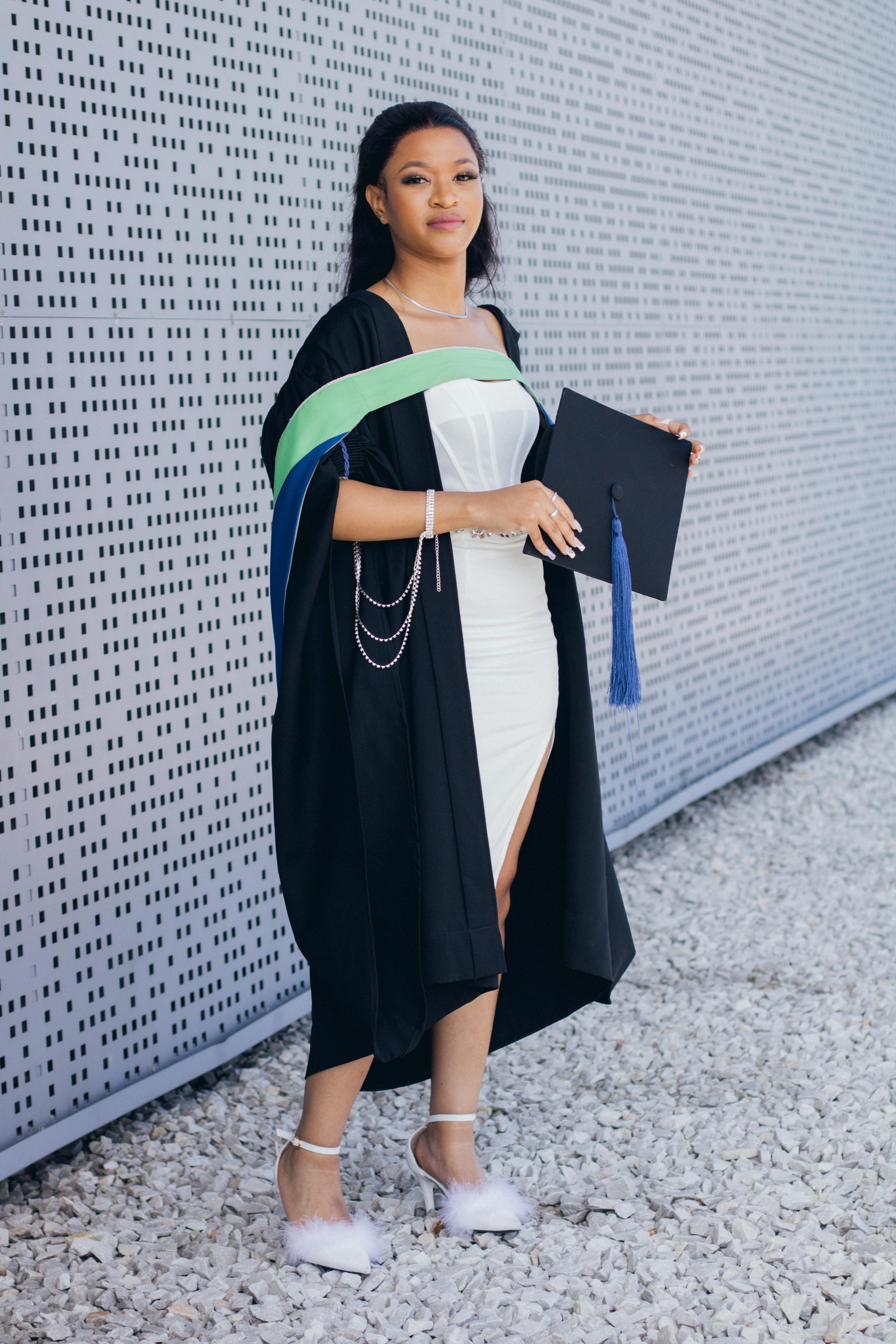 Brunette in Dress under Graduation Gown · Free Stock Photo