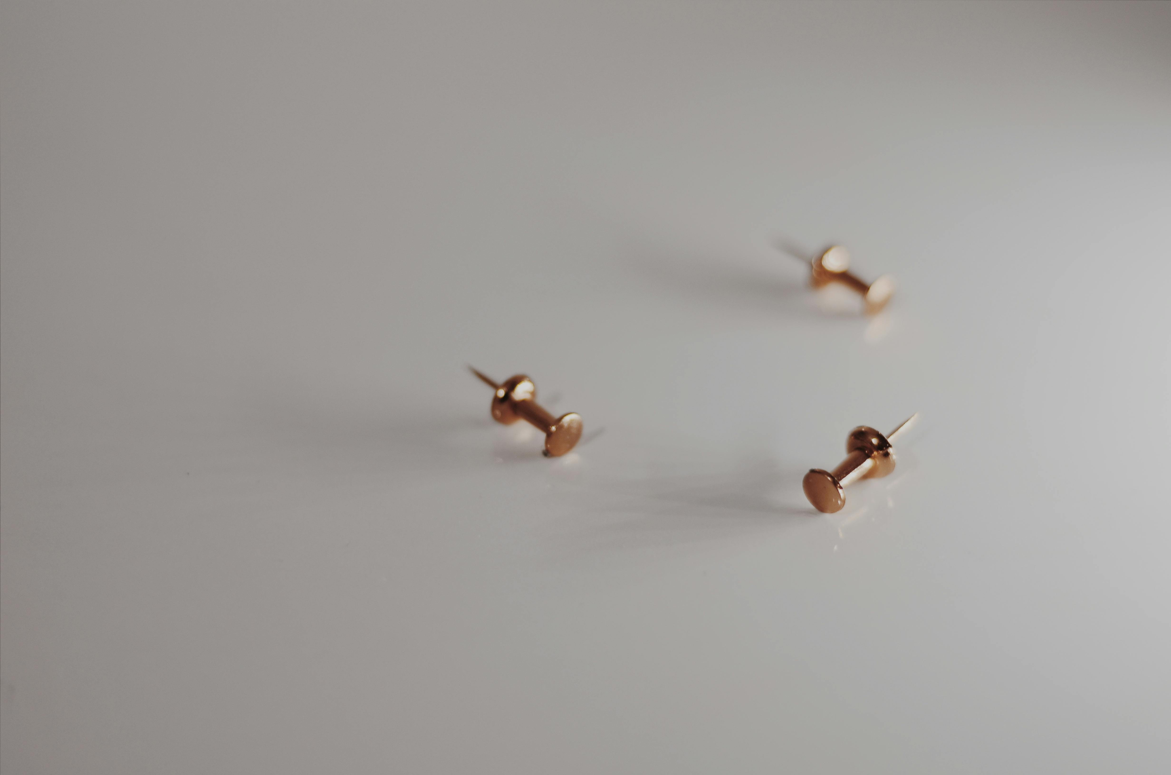Three Gold Tacks · Free Stock Photo