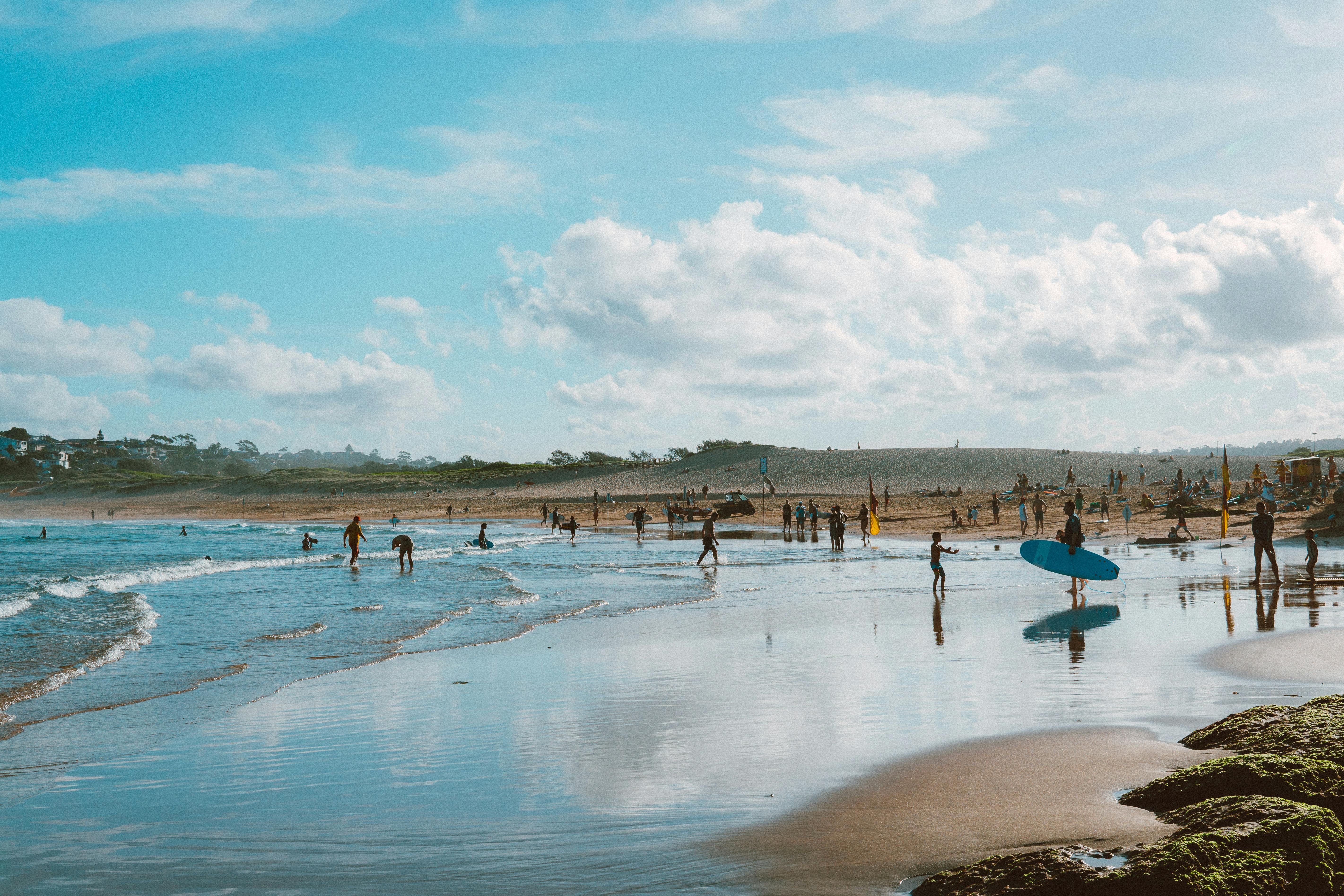 People on Beach Under Cloudy Sky · Free Stock Photo