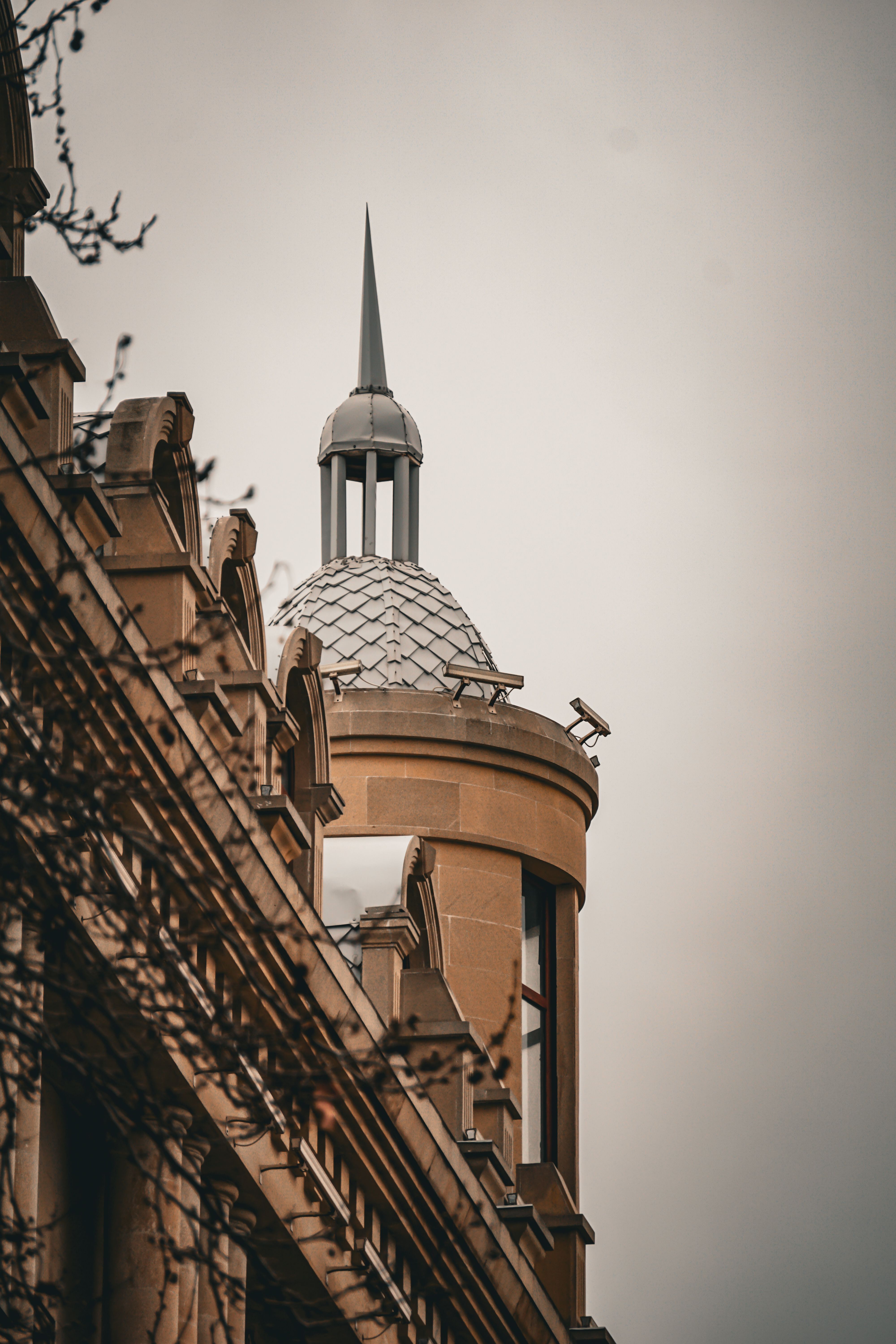 Building Tower behind Wall · Free Stock Photo