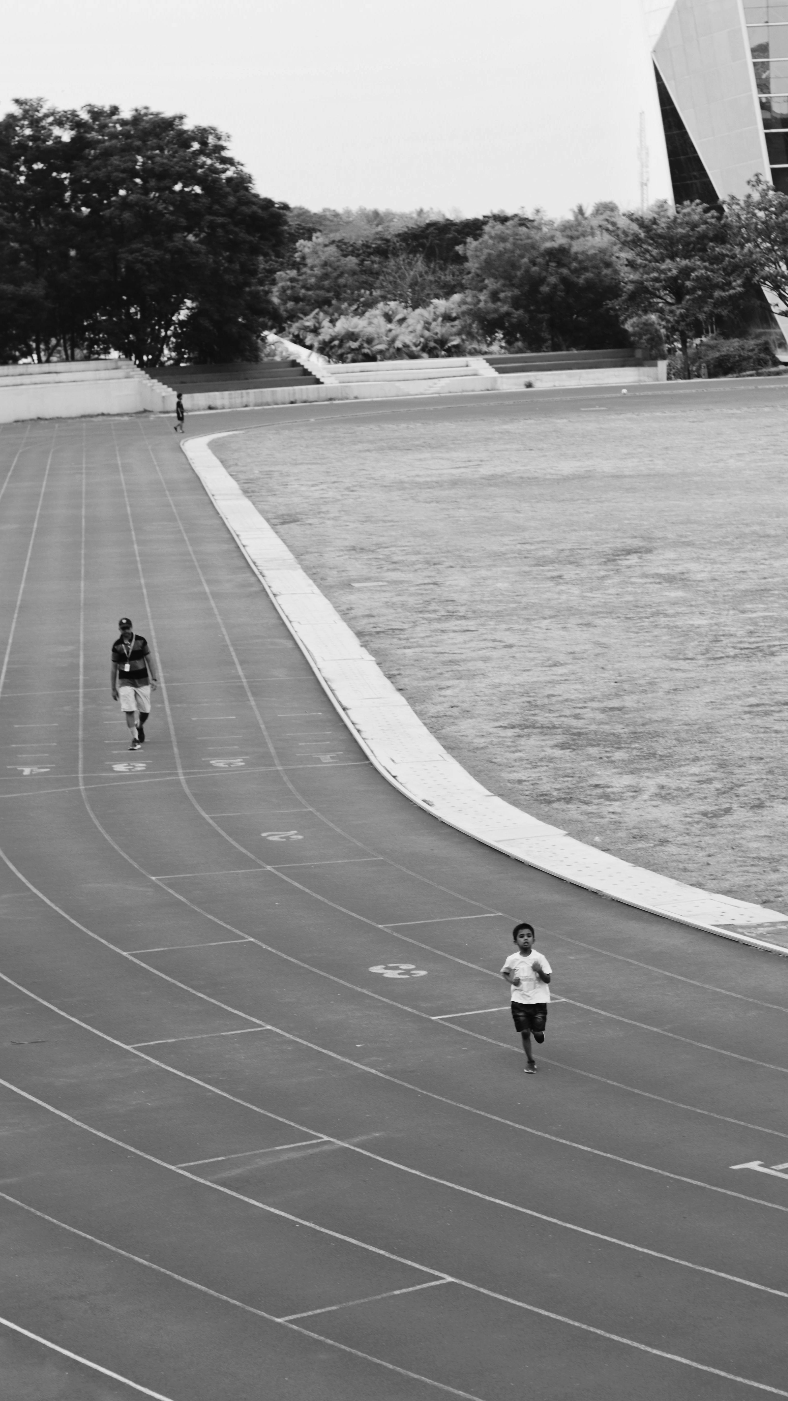 Man and Boy on Running Track · Free Stock Photo