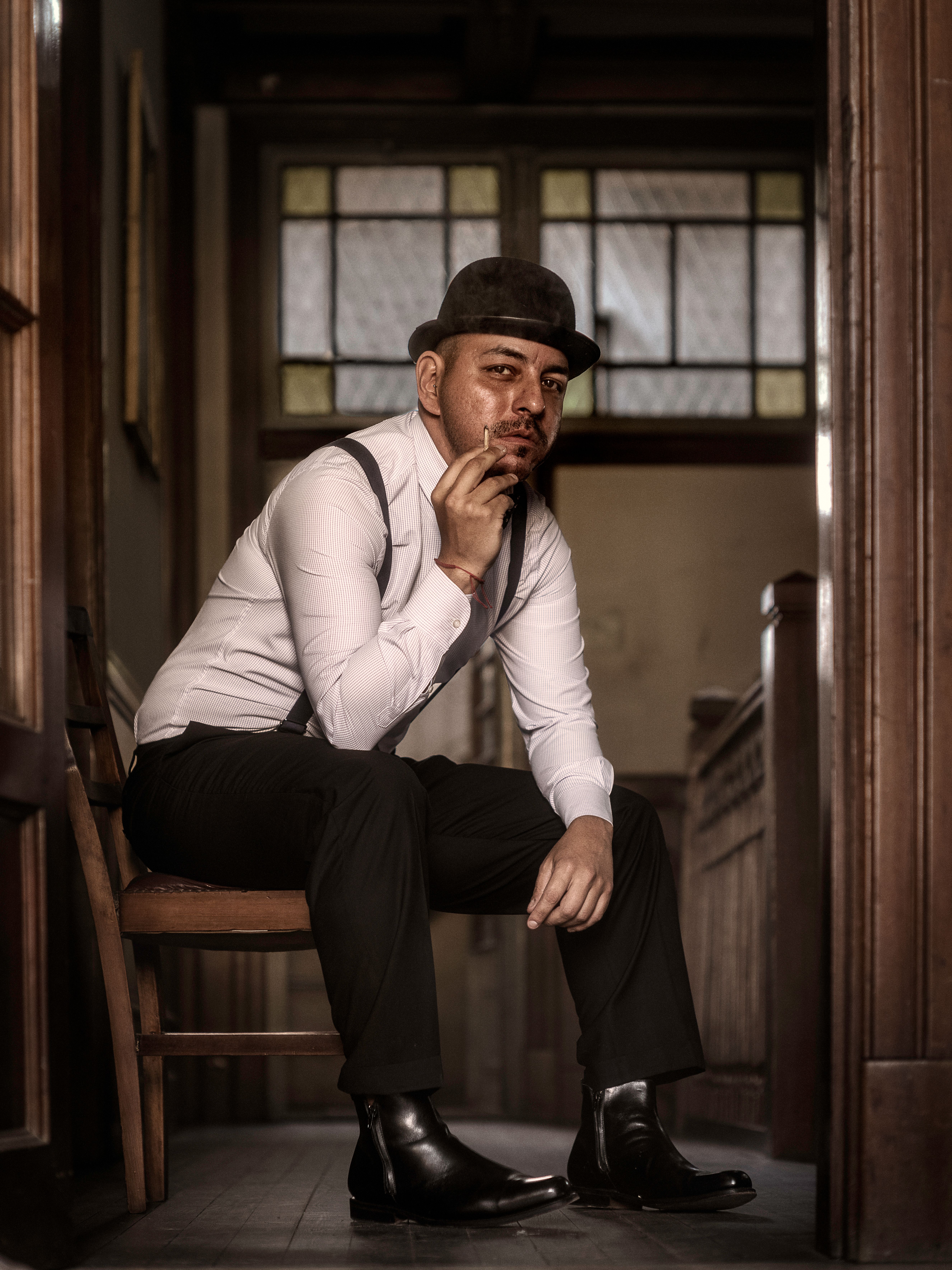 Elegant Man Sitting on a Chair and Smoking a Cigarette · Free Stock Photo